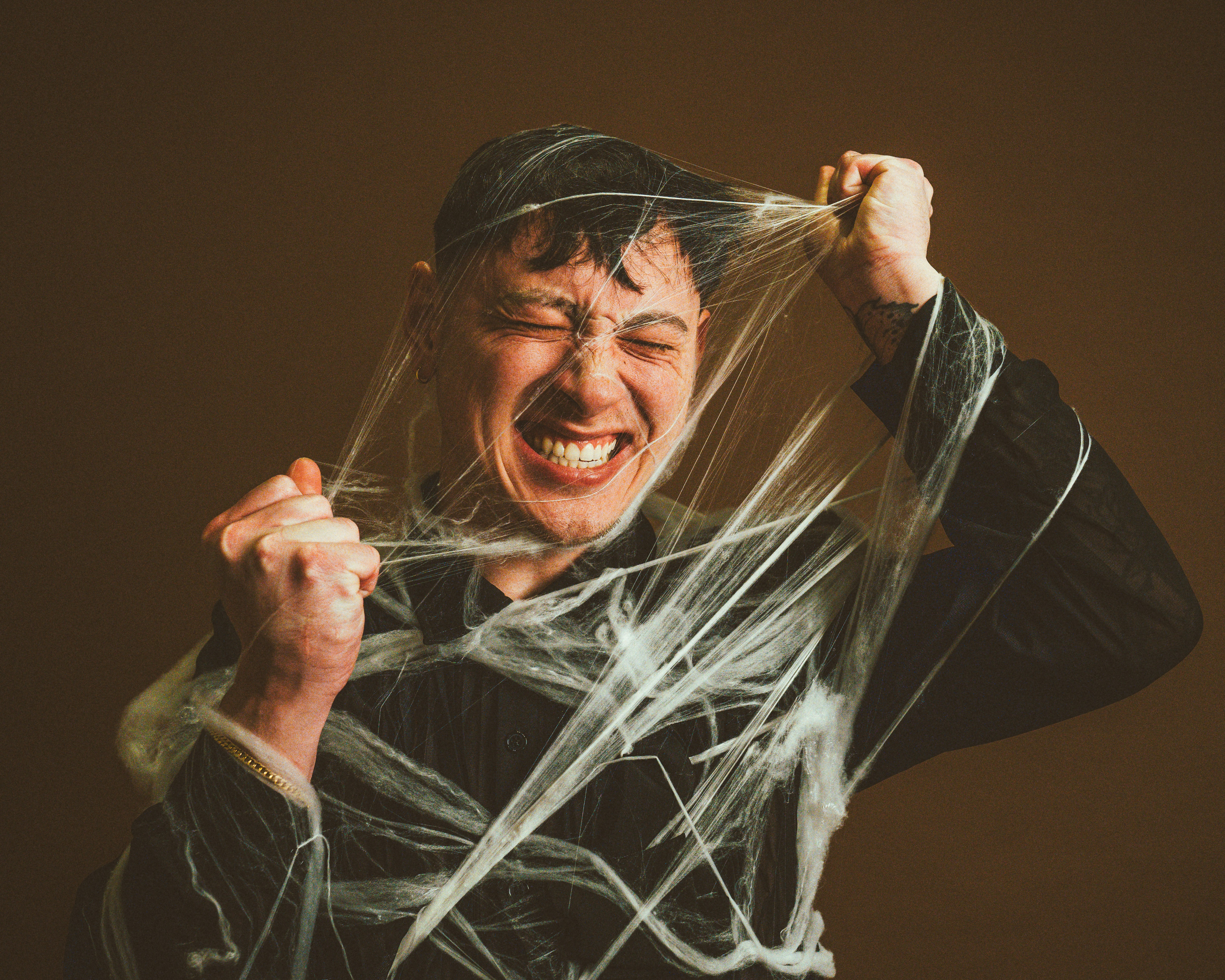 A man holding a string wrapped around his head photo – Free Grey Image ...