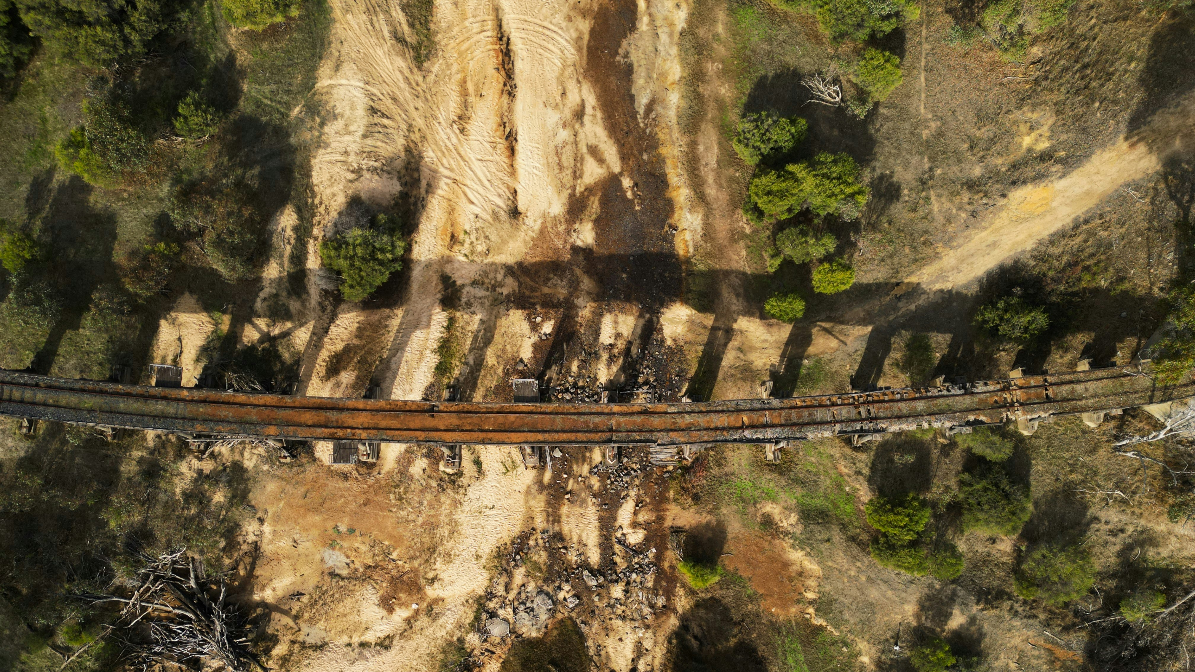 Dusty Rails Across the Canyon: Aerial Slice of Dry Terrain