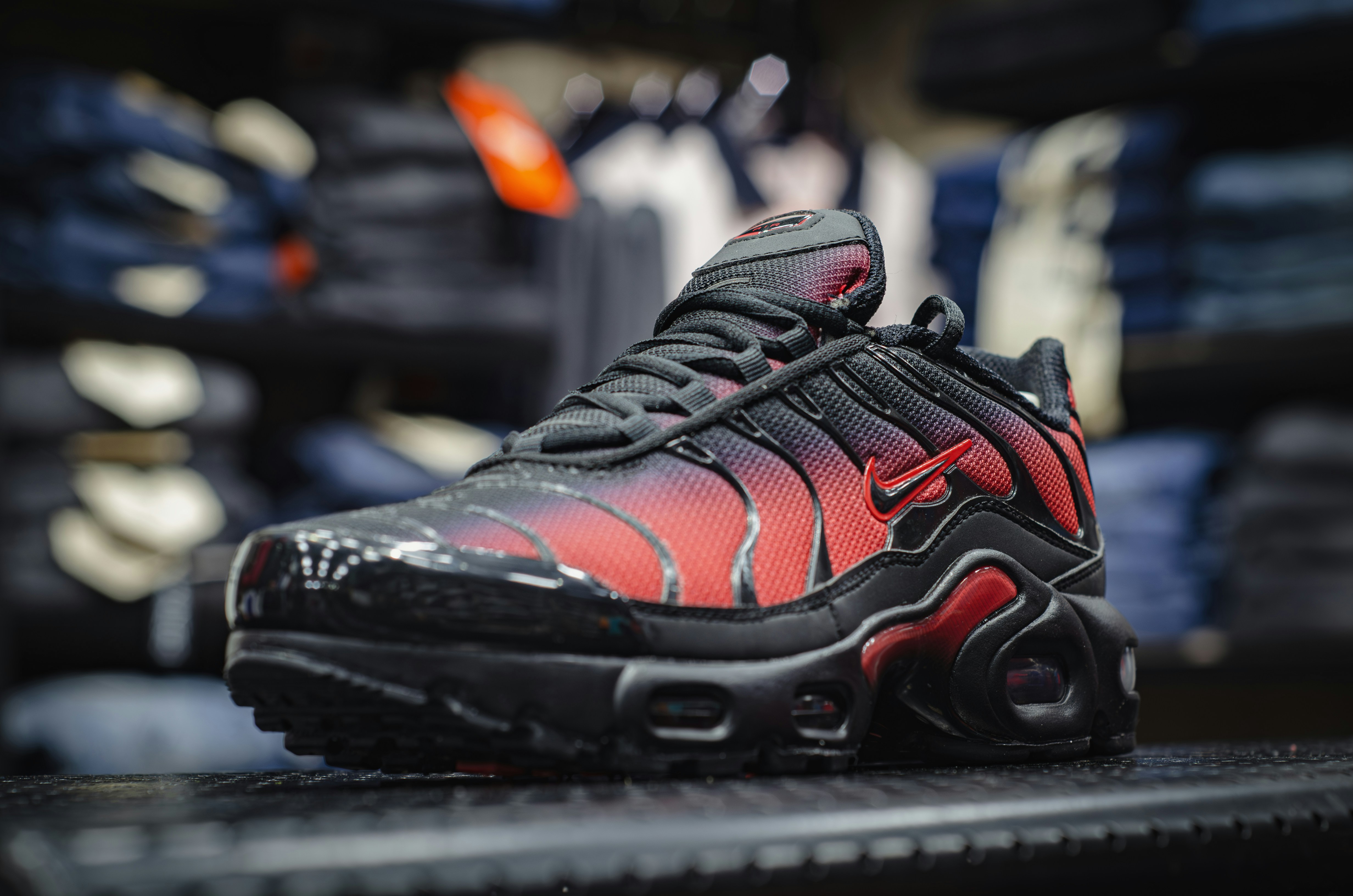 A pair of black and red sneakers on a table photo – Free Shoe Image on ...