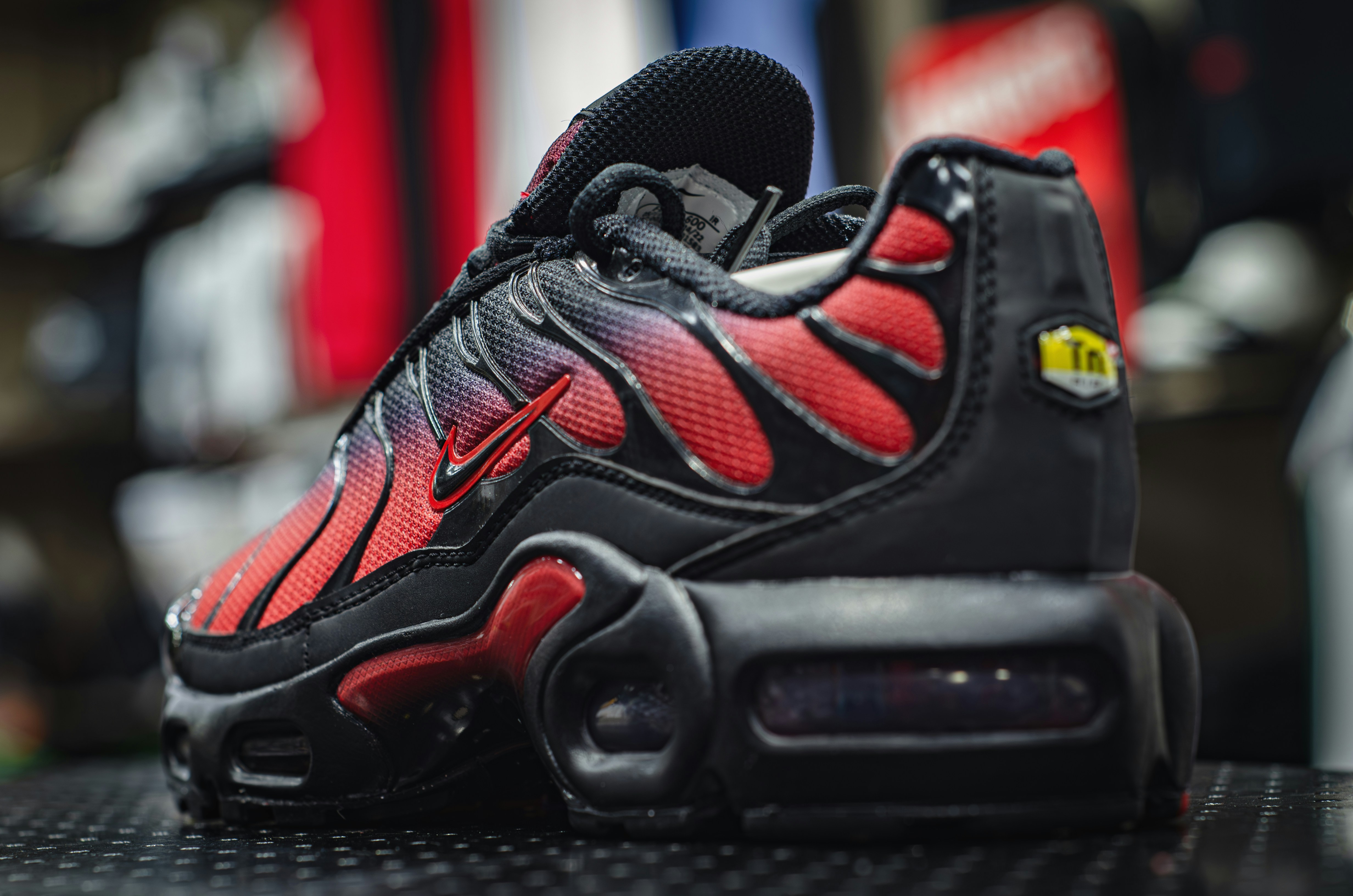 A pair of black and red sneakers on a table photo – Free Shoe Image on ...