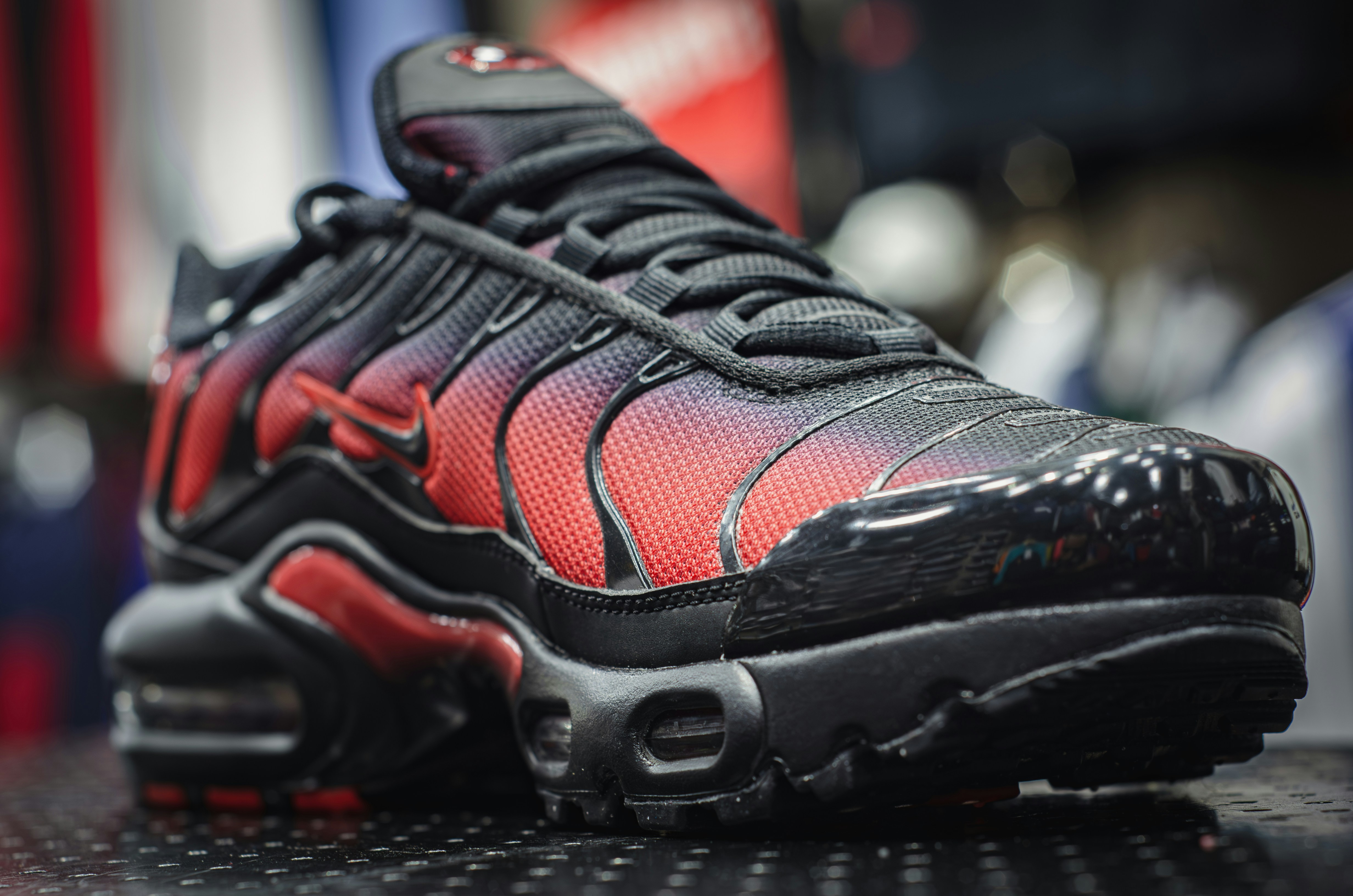 A pair of black and red sneakers on a table photo – Free Shoe Image on ...