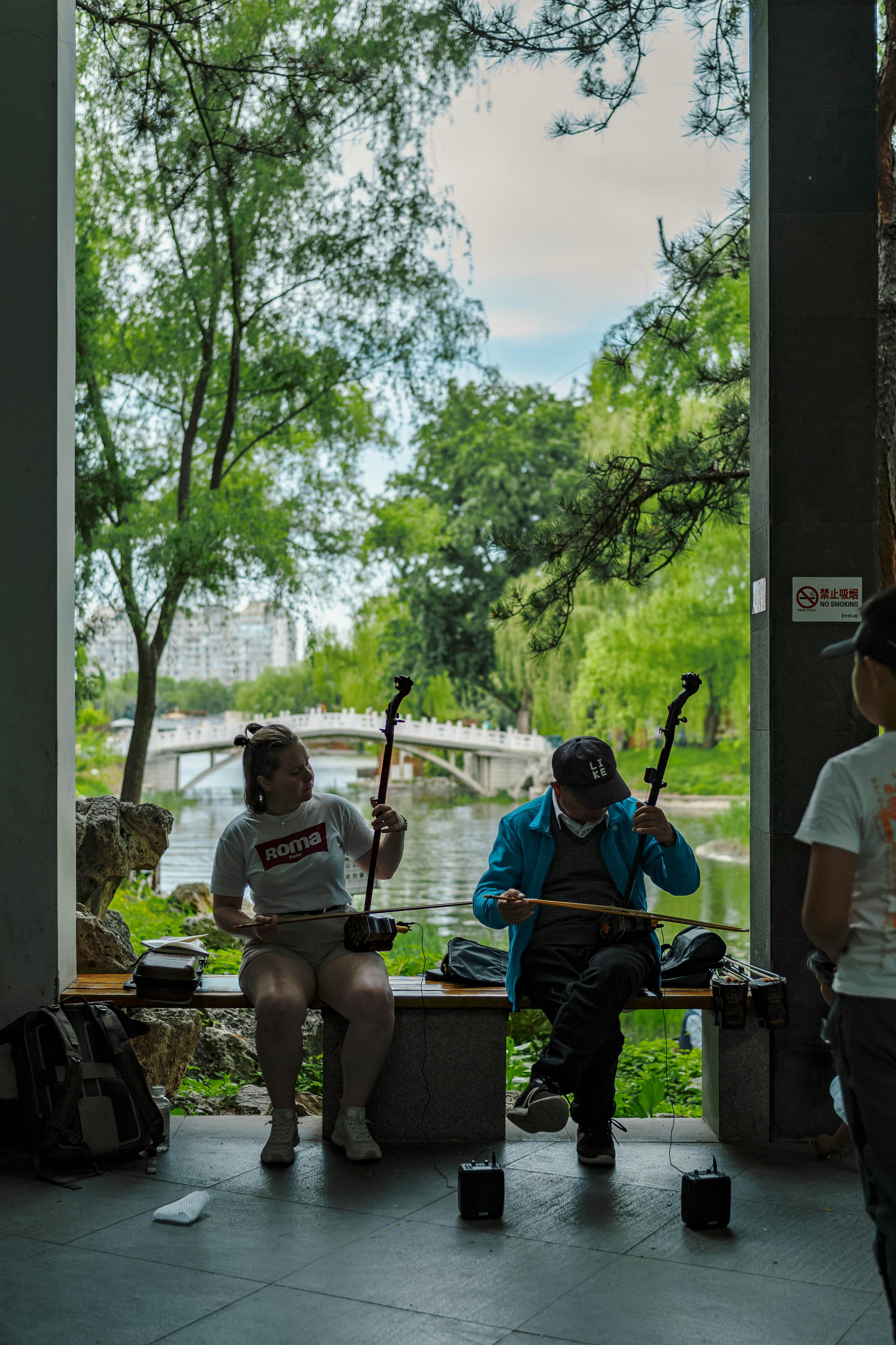 Riverbank Duet: Two Tar Players in a Park Oasis