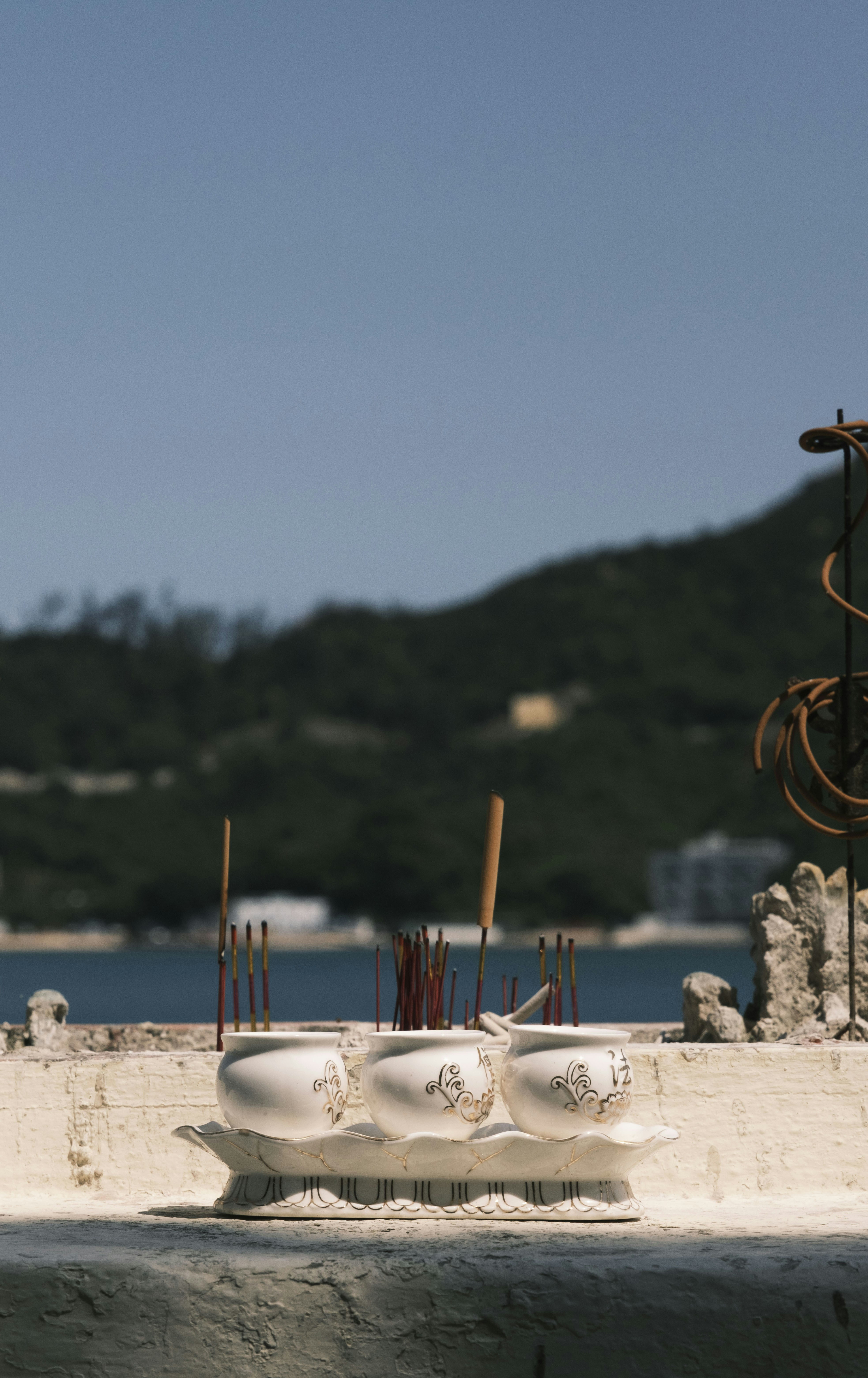 Incense on the Sea Wall: White Ceramics and a Tranquil Horizon