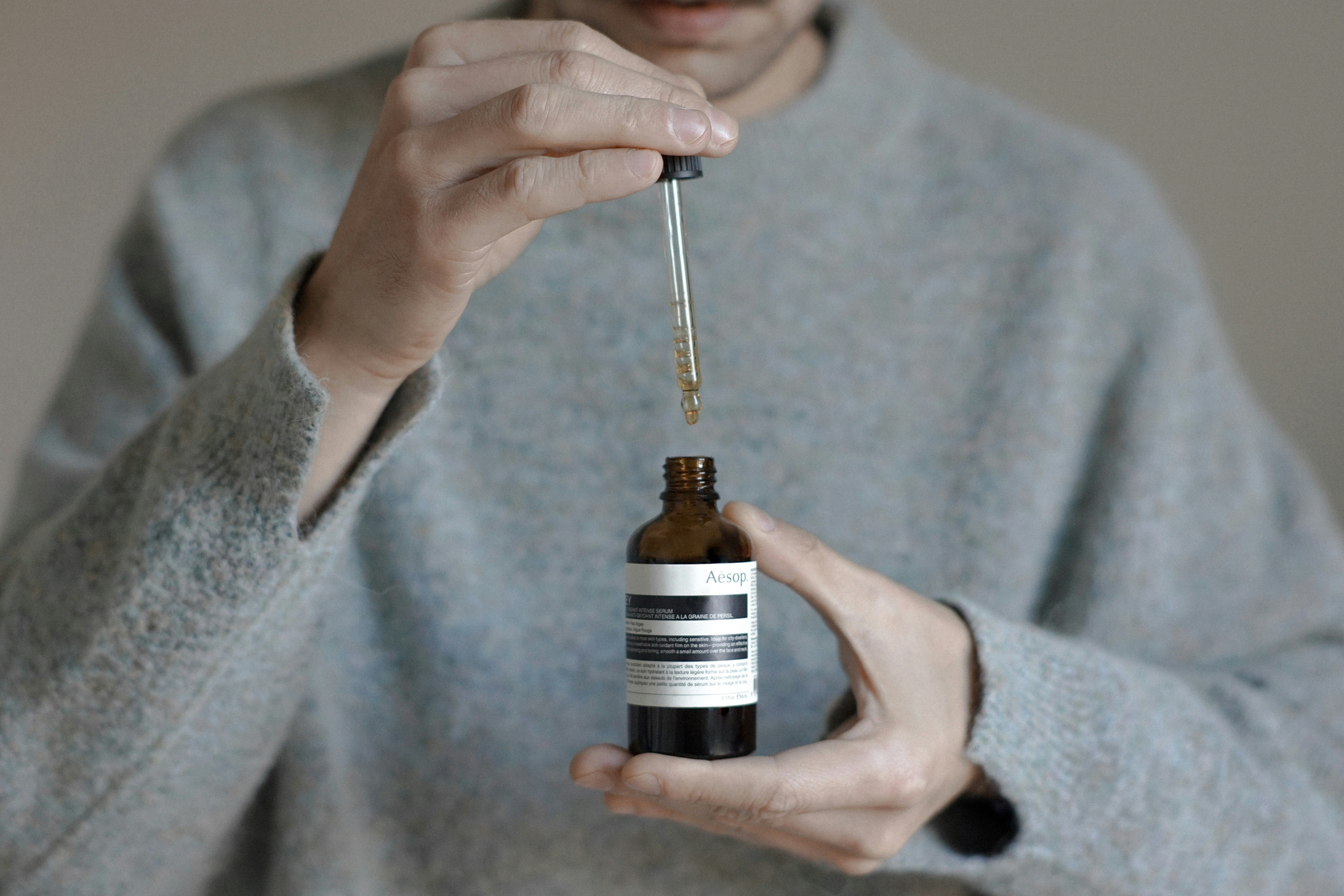 A person holding a bottle with a dropper photo – Free Grey Image on ...