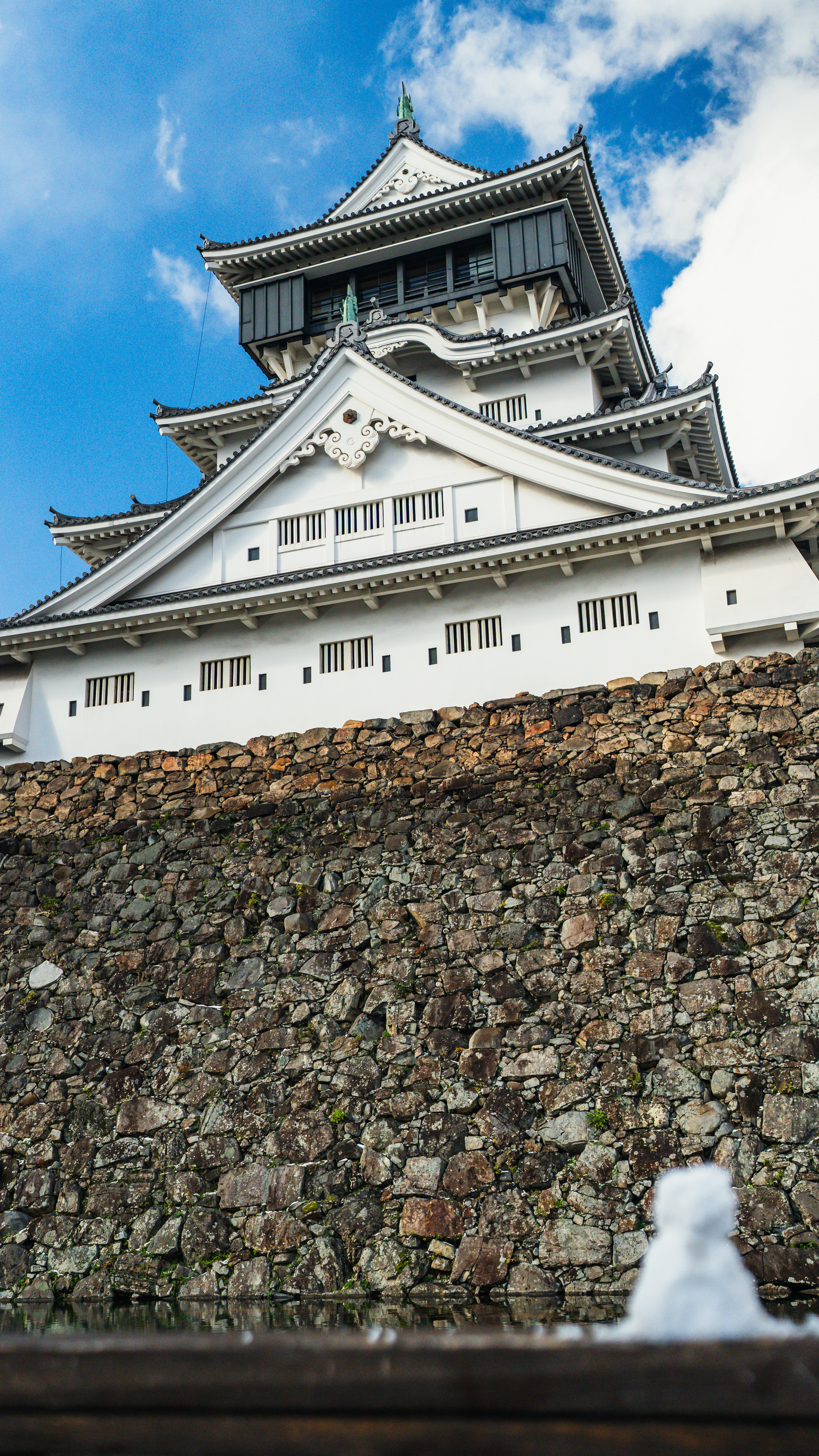 Tiered White Fortress Rising Above a Weathered Stone Base