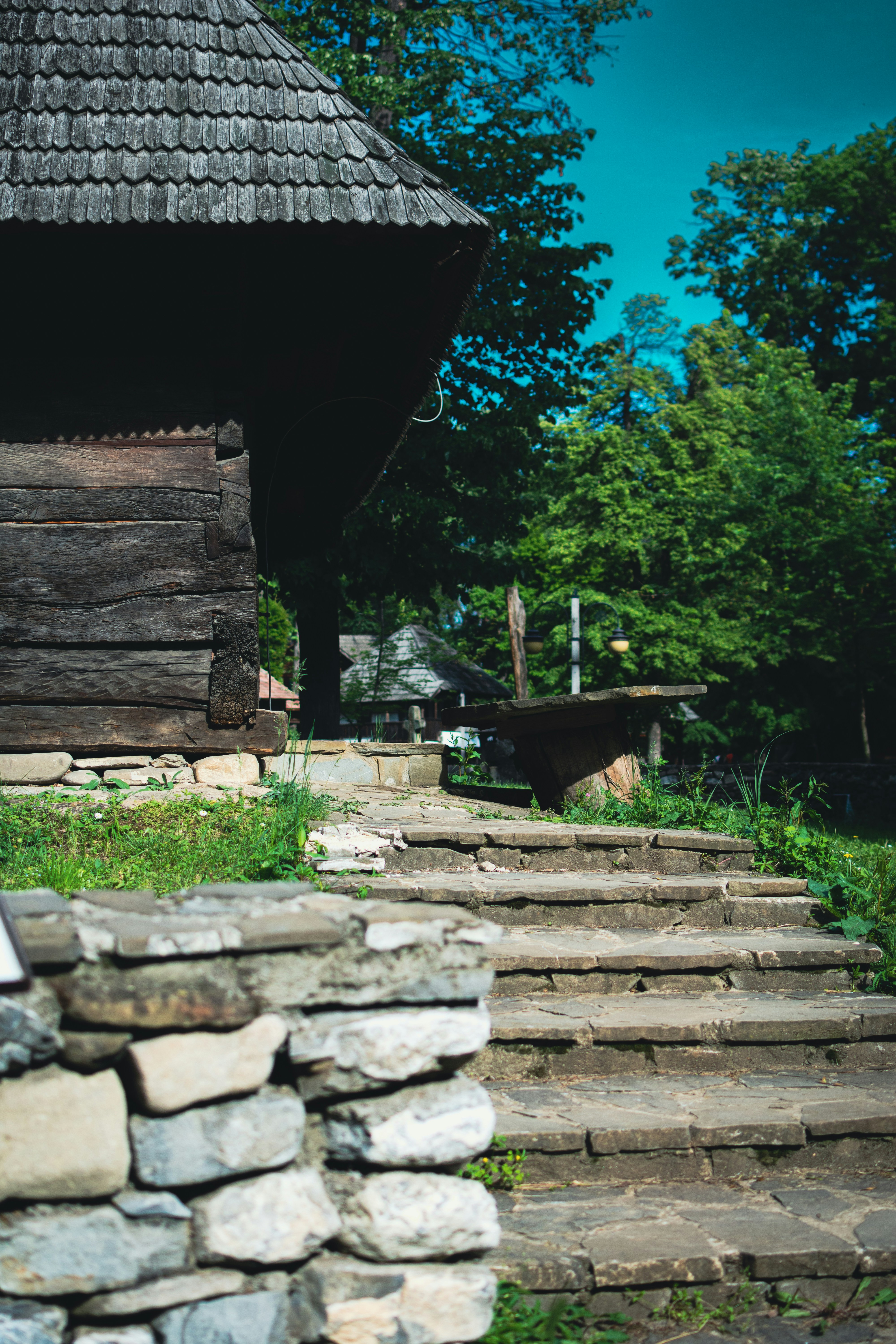 Weathered Timber Hut at the Foot of Sun-Washed Stone Steps