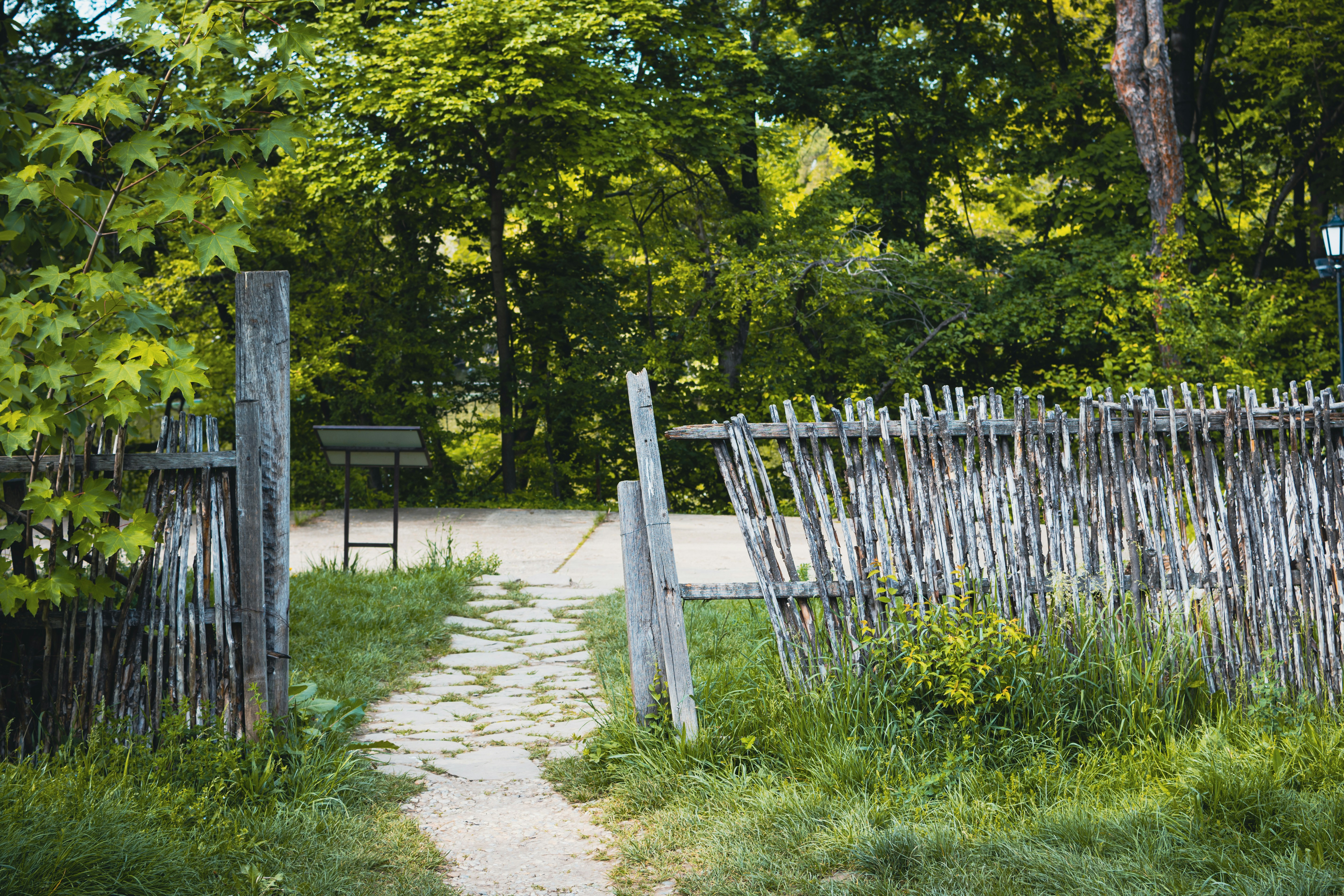 a path leading to a wooden gate in a park