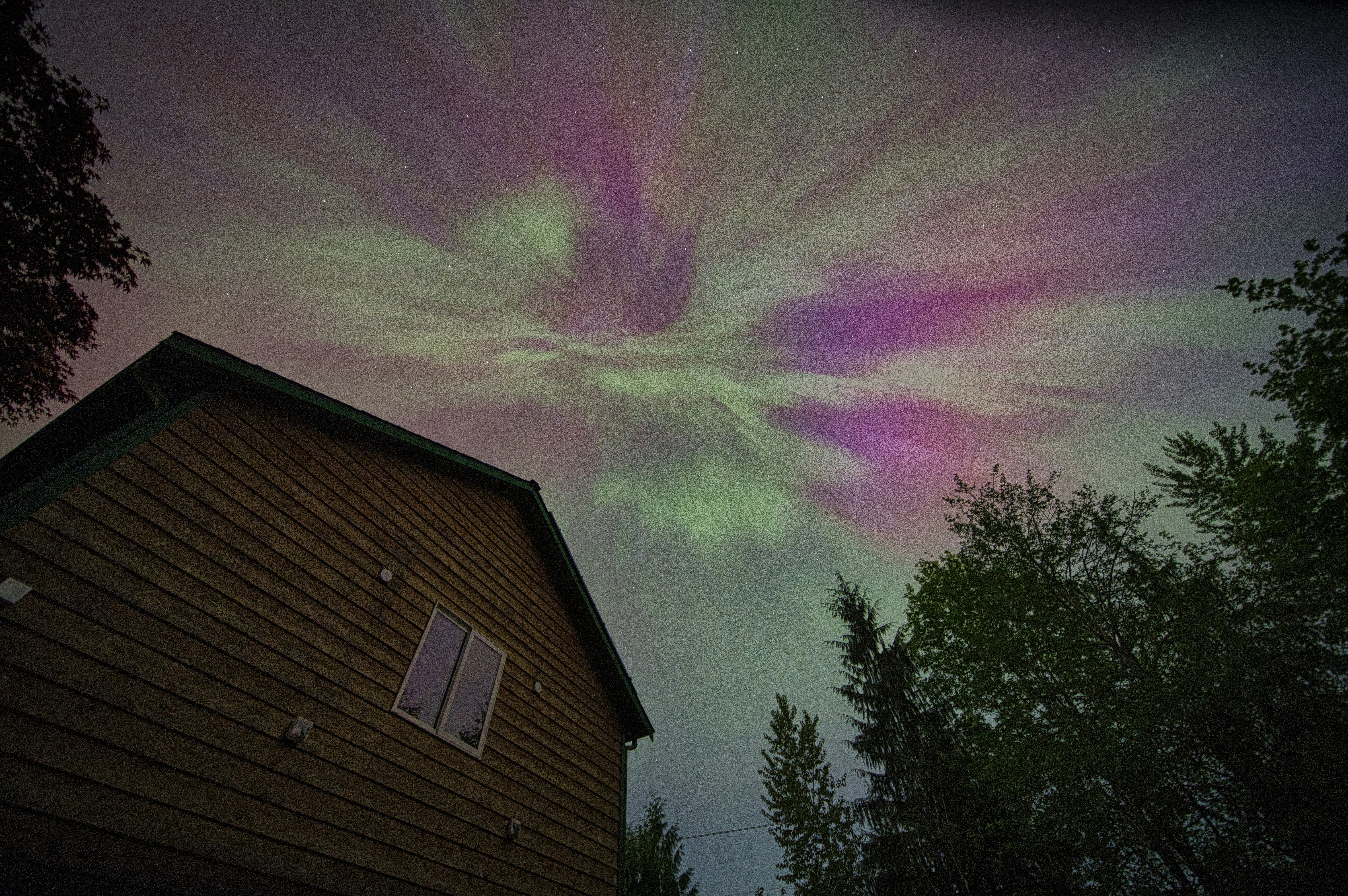 Northern Lights Crown Over a Quiet Timber Cabin