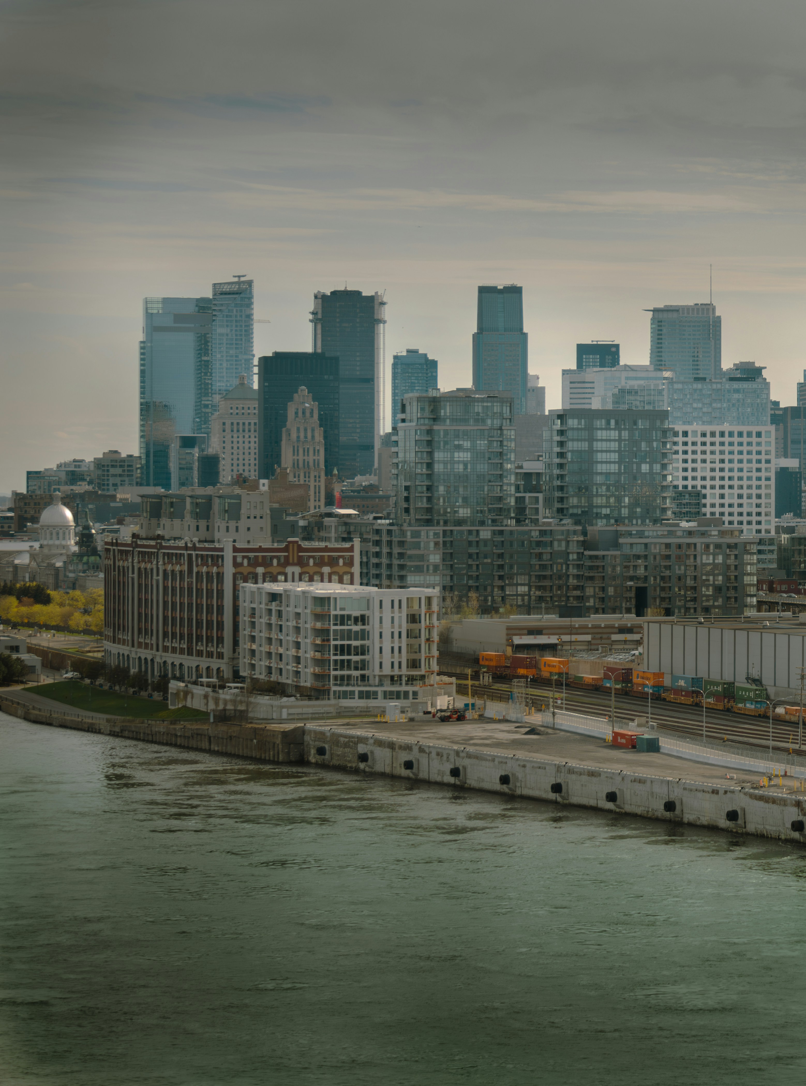 Urban Riverfront Cascade: Towers and Trains Along the Waterfront