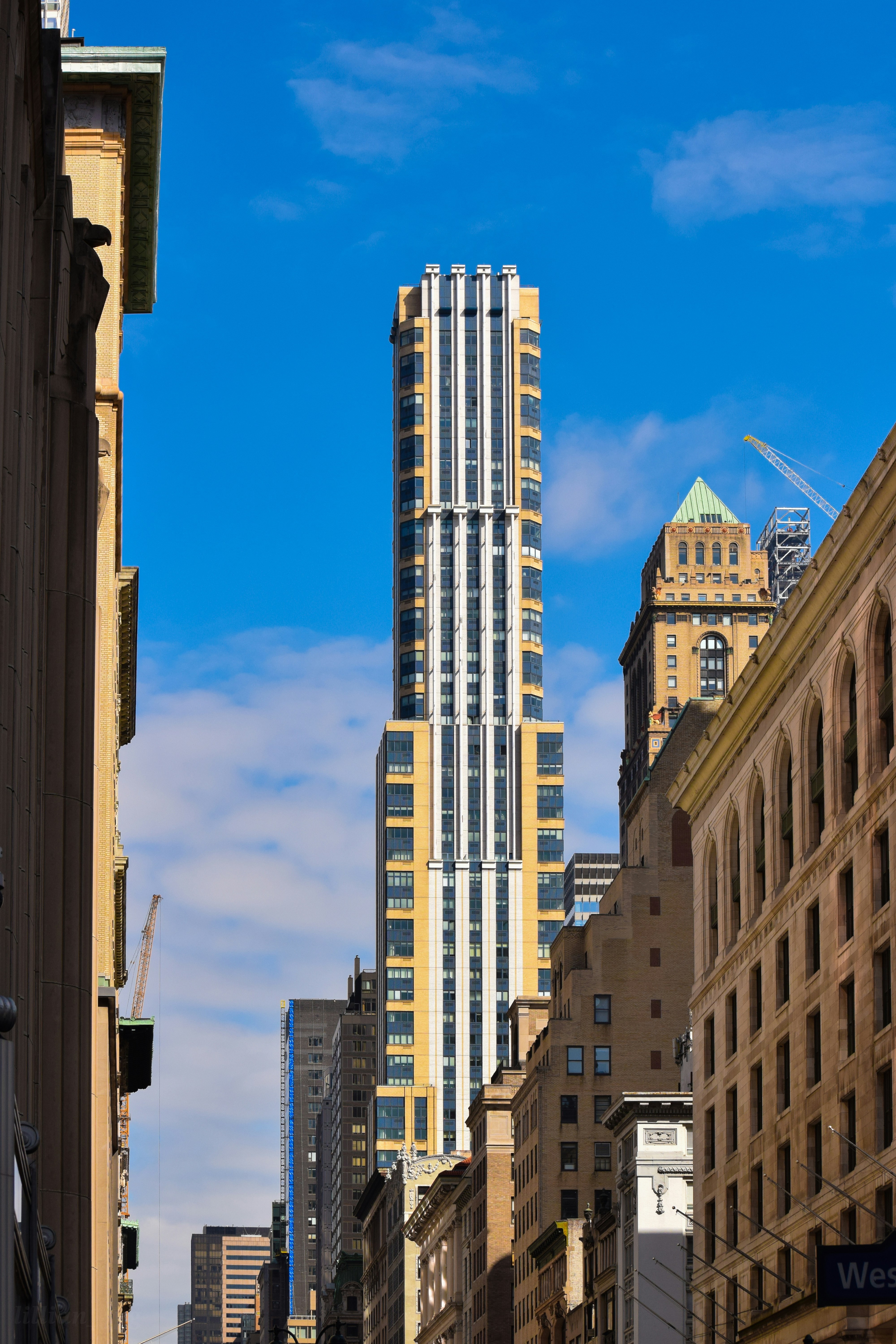 A tall building towering over a city filled with tall buildings photo ...