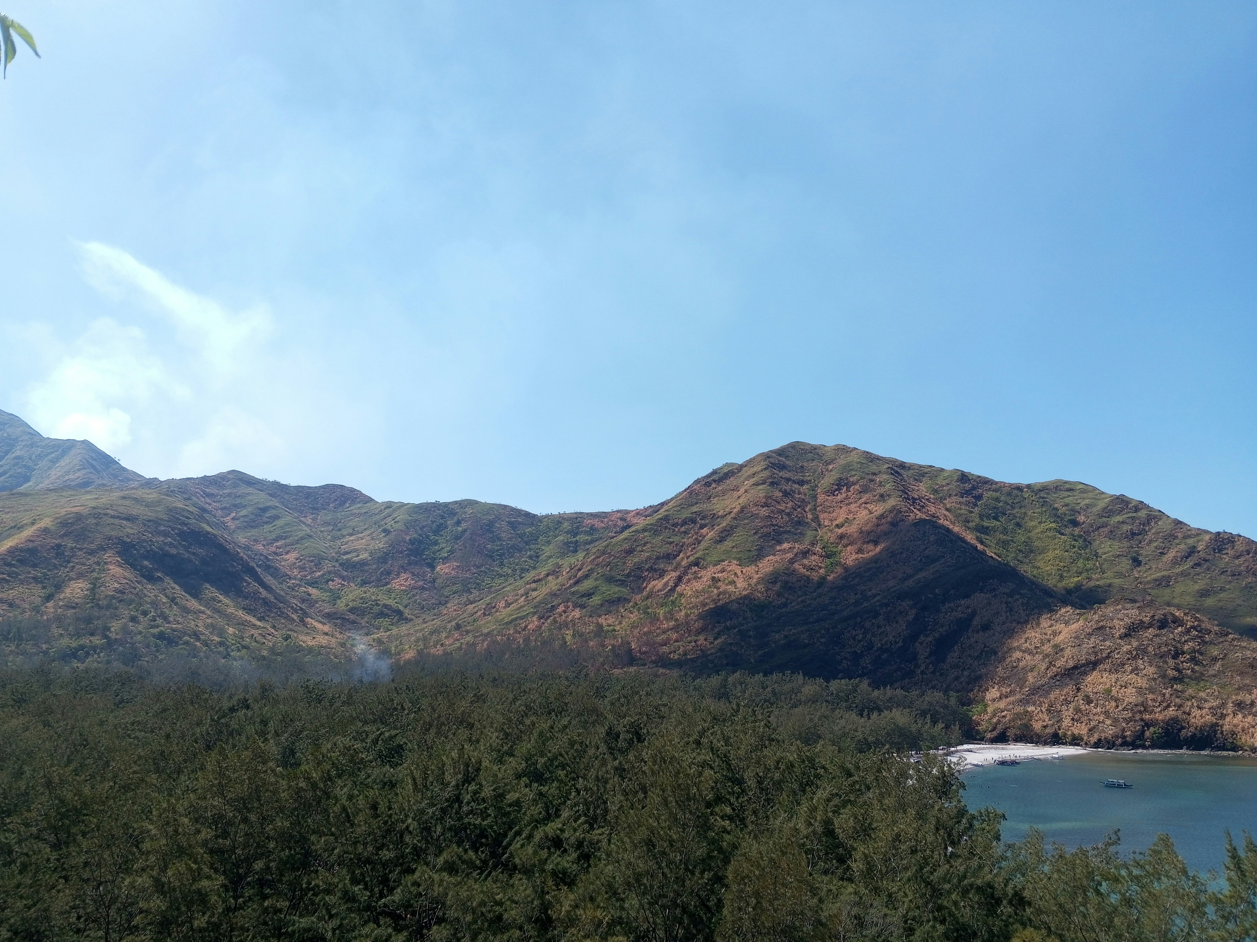 a view of a mountain range with a body of water in the foreground