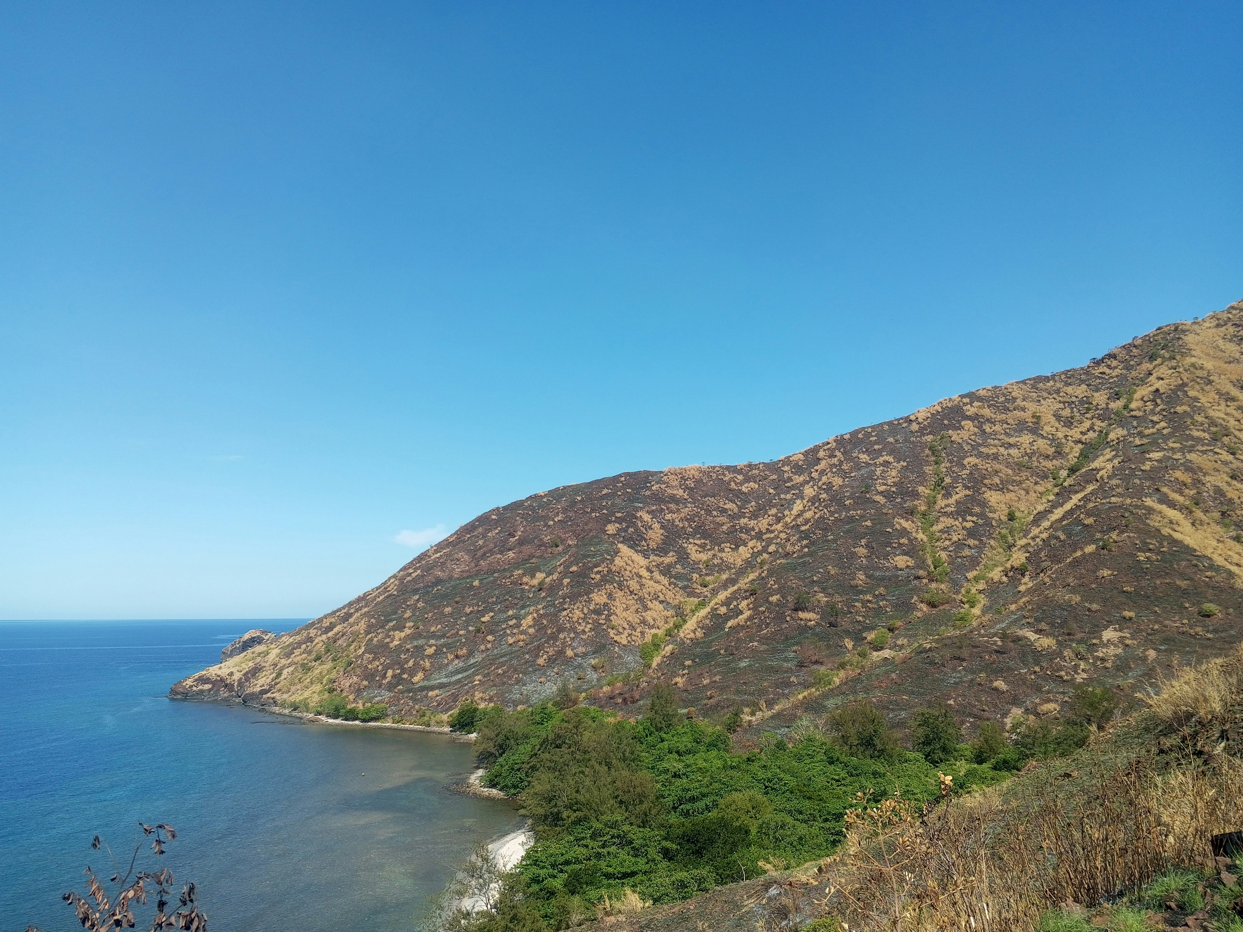 A mountain with a body of water in the middle of it photo – Free Nature ...