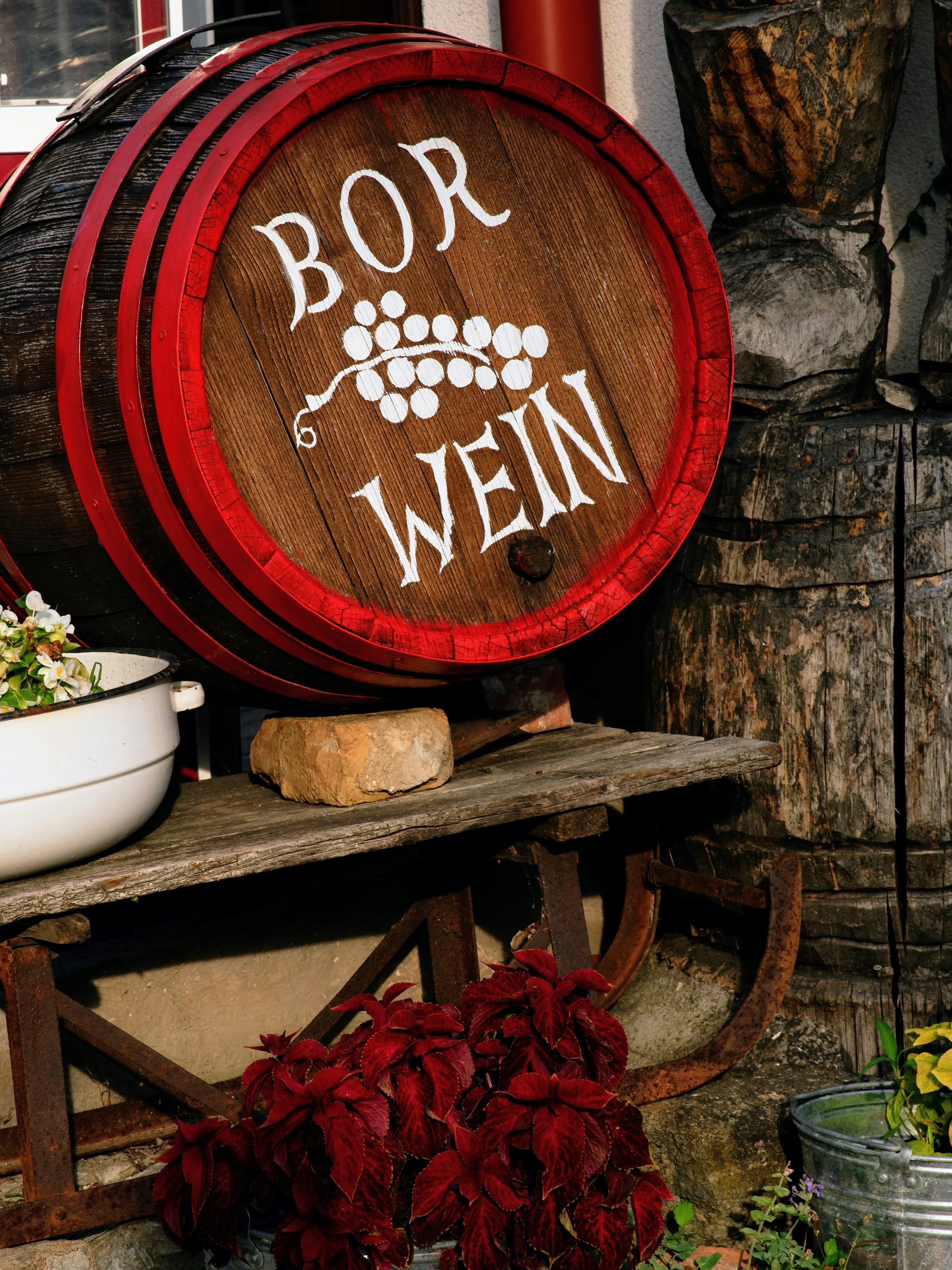 Grapevine Glyph on a Weathered Barrel in a Rustic Courtyard