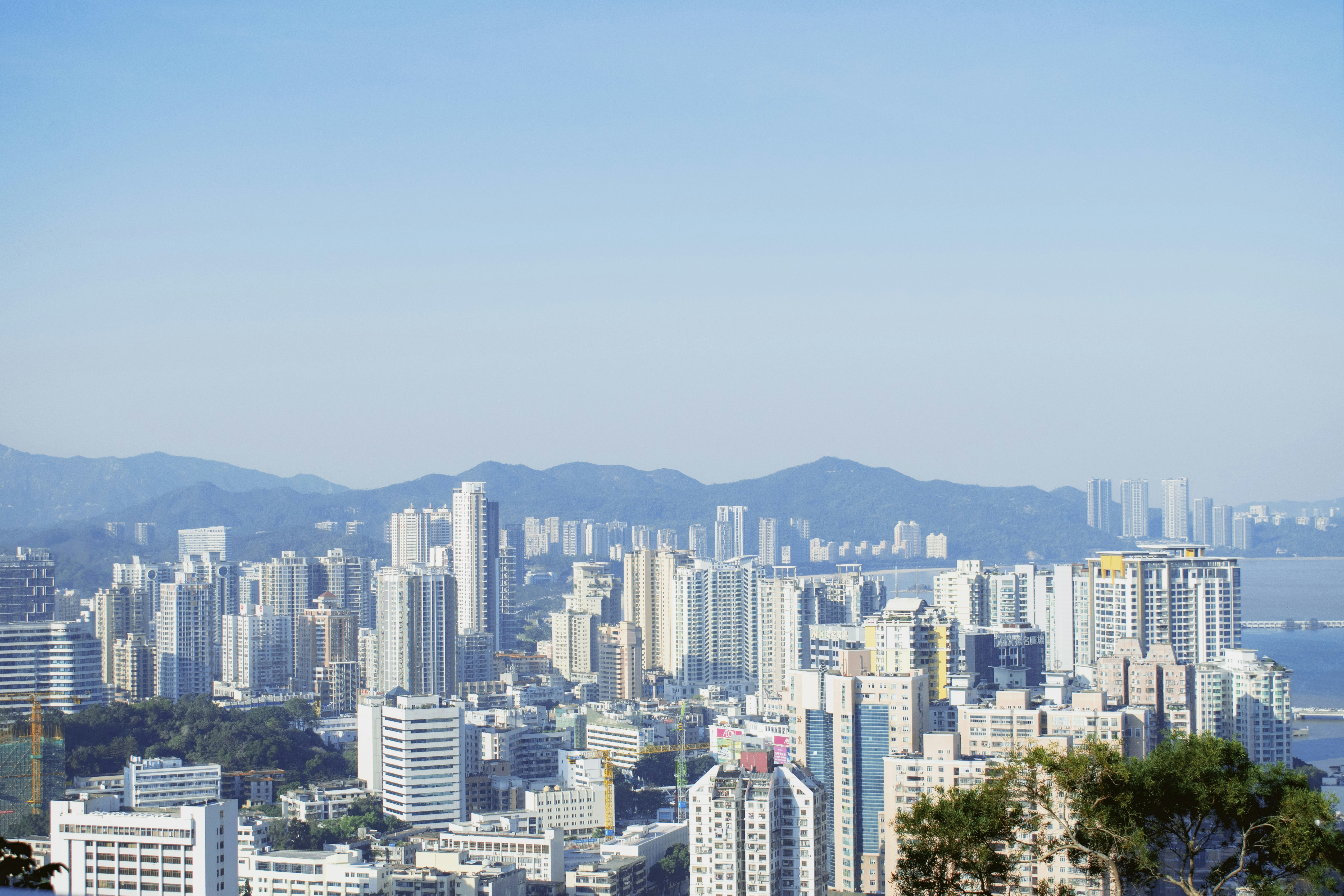 A view of a city with mountains in the background photo – Free Building ...