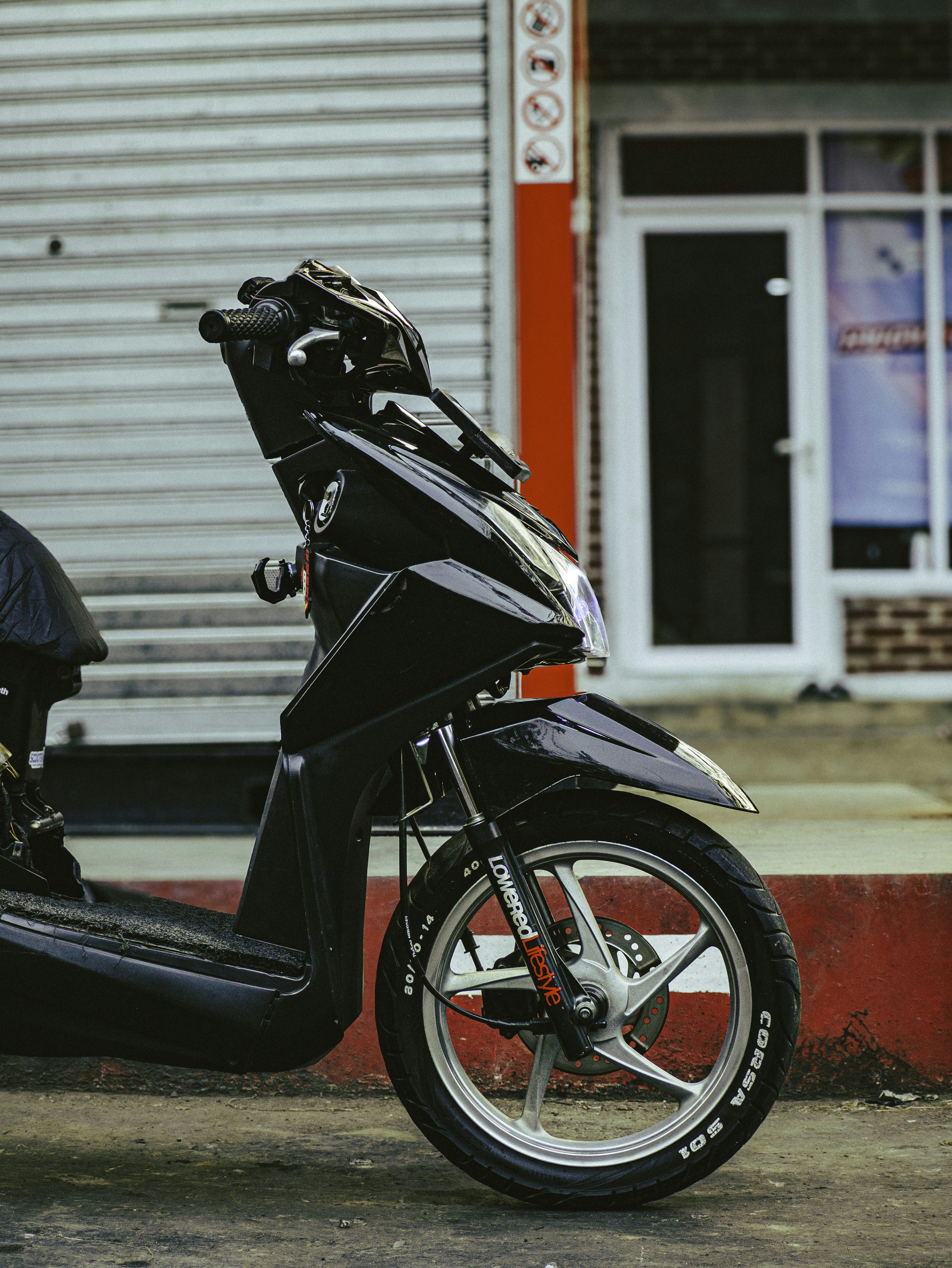 a motor scooter parked in front of a building