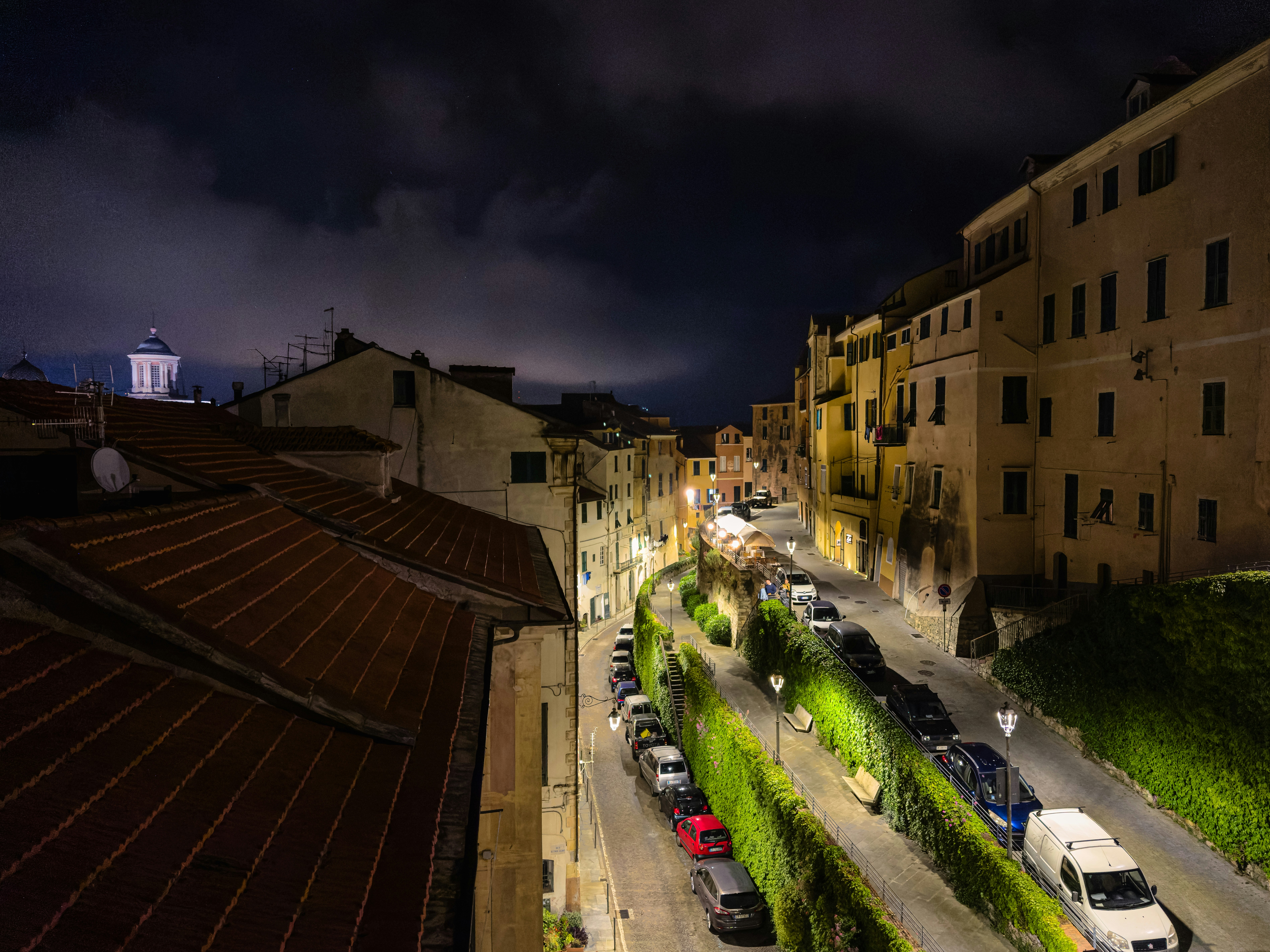 Curved Night Street in a Hillside Town: Ivy-Walled Alleys and Lantern Light