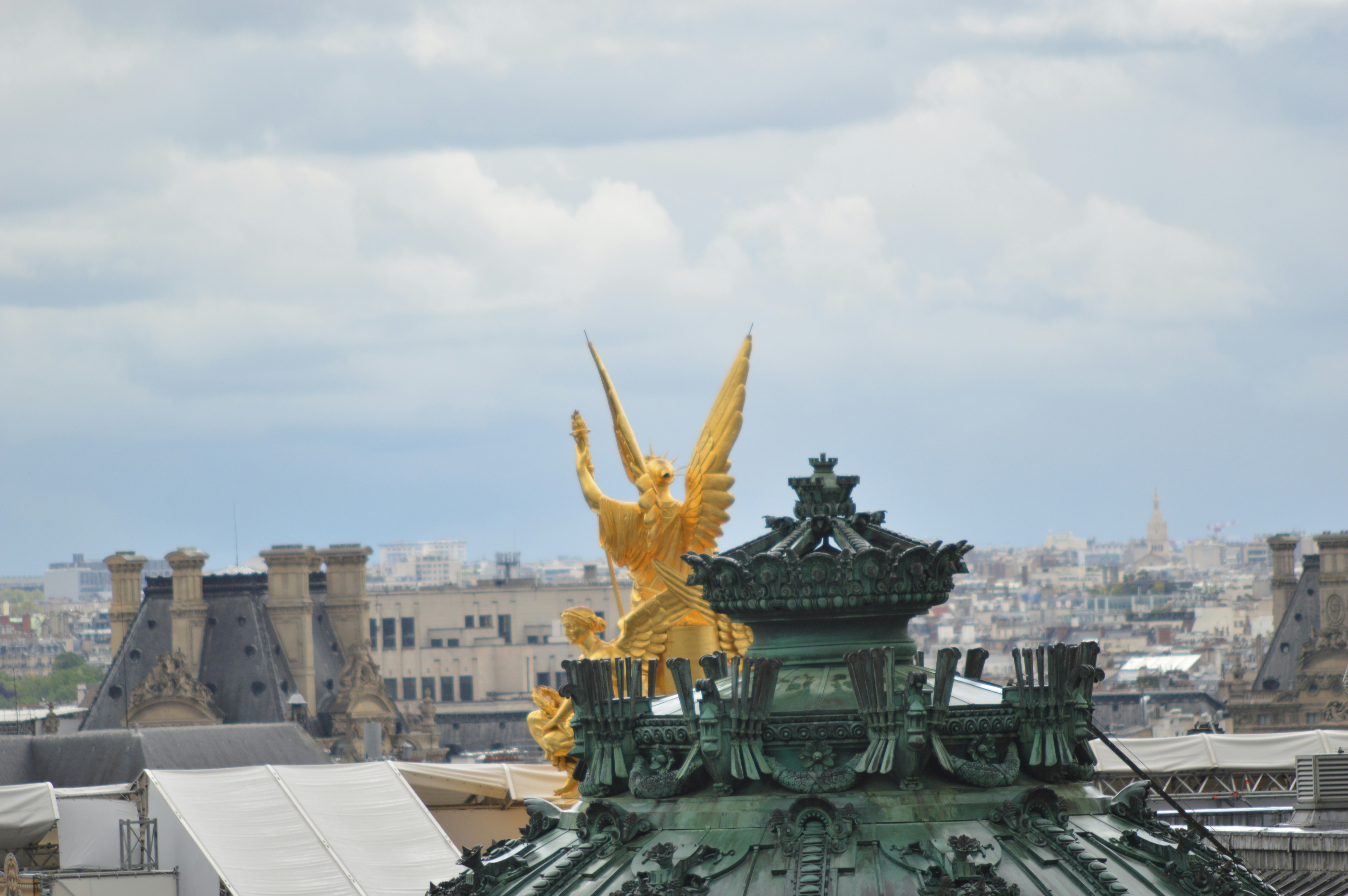 Gilded Guardian: A Rooftop Finial Reaching Toward the Sky