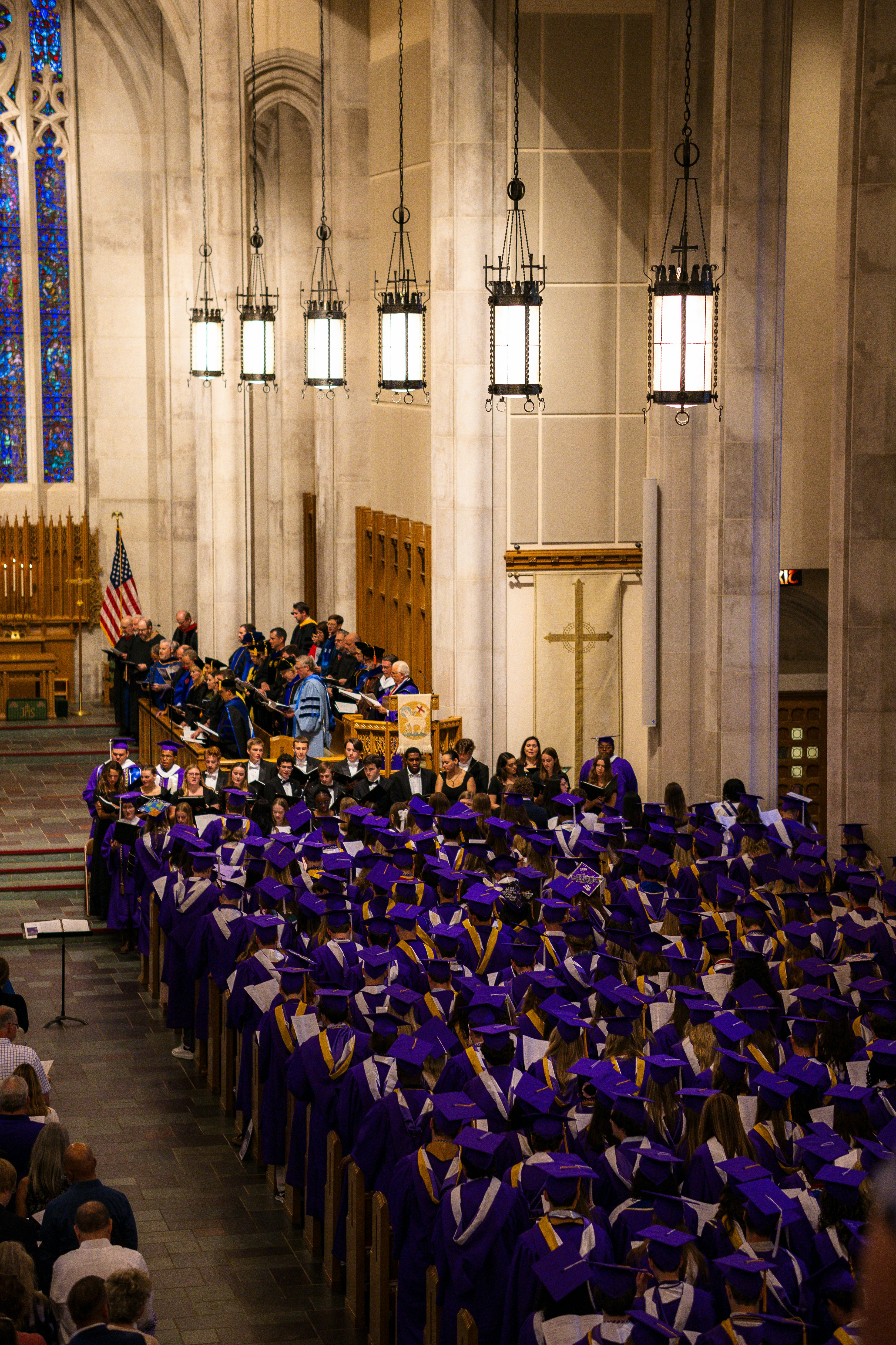 Aisle of Violet Robes: Graduation Ceremony Amid Cathedral Lights
