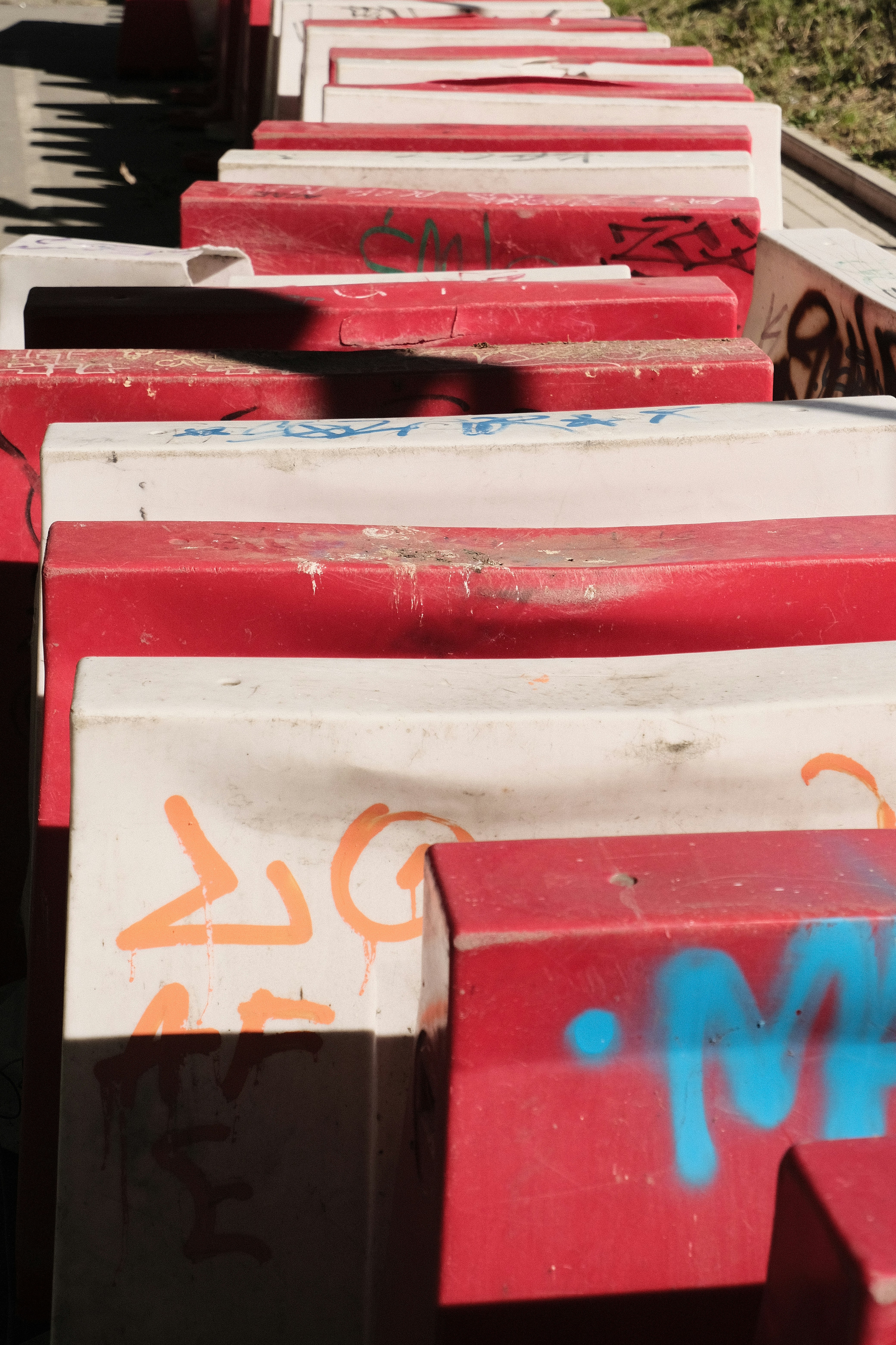 Sunlit Row of Graffiti-Tagged Panels