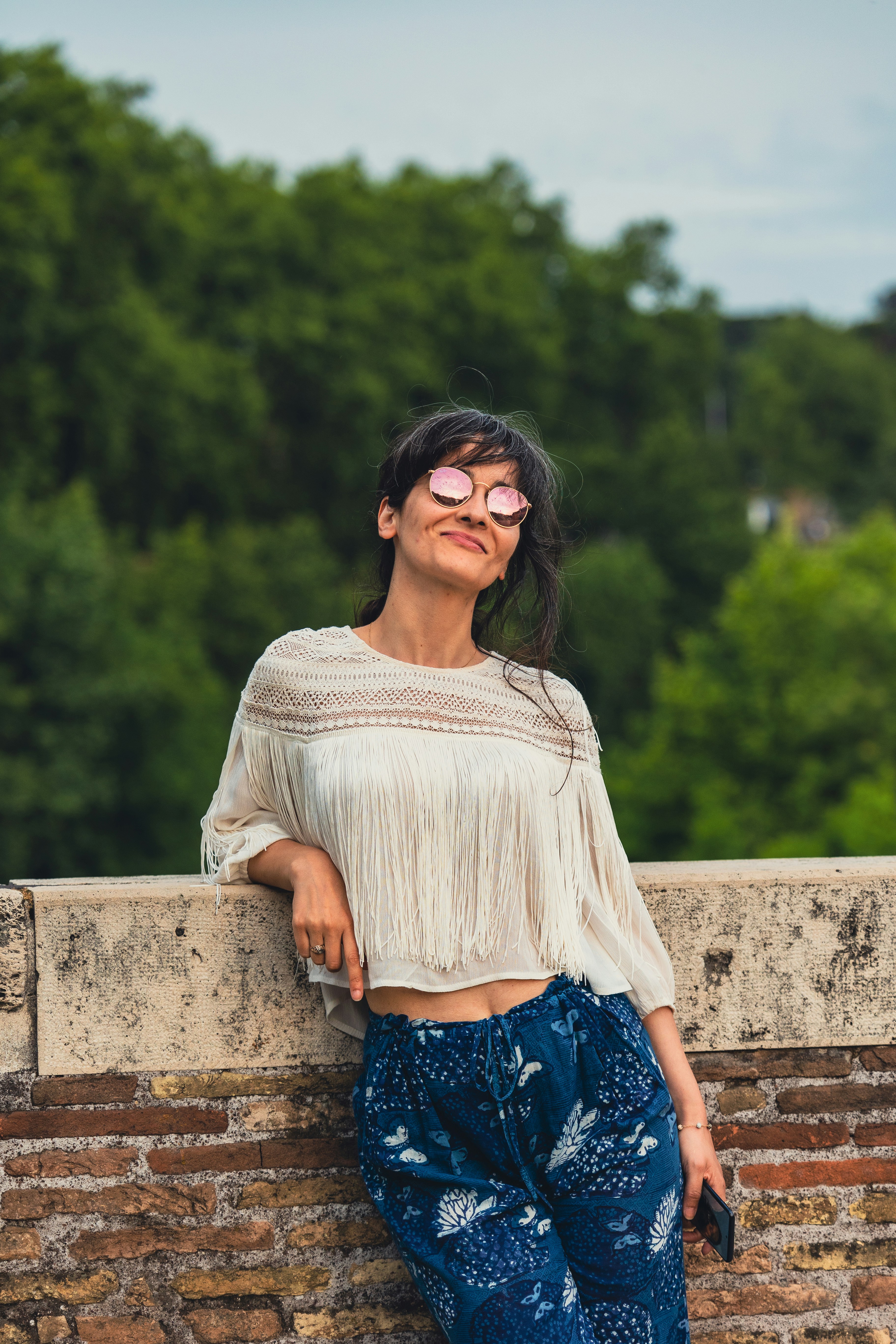 Fringe, Glass and Greenery: A Quiet Portrait by the Brick Wall