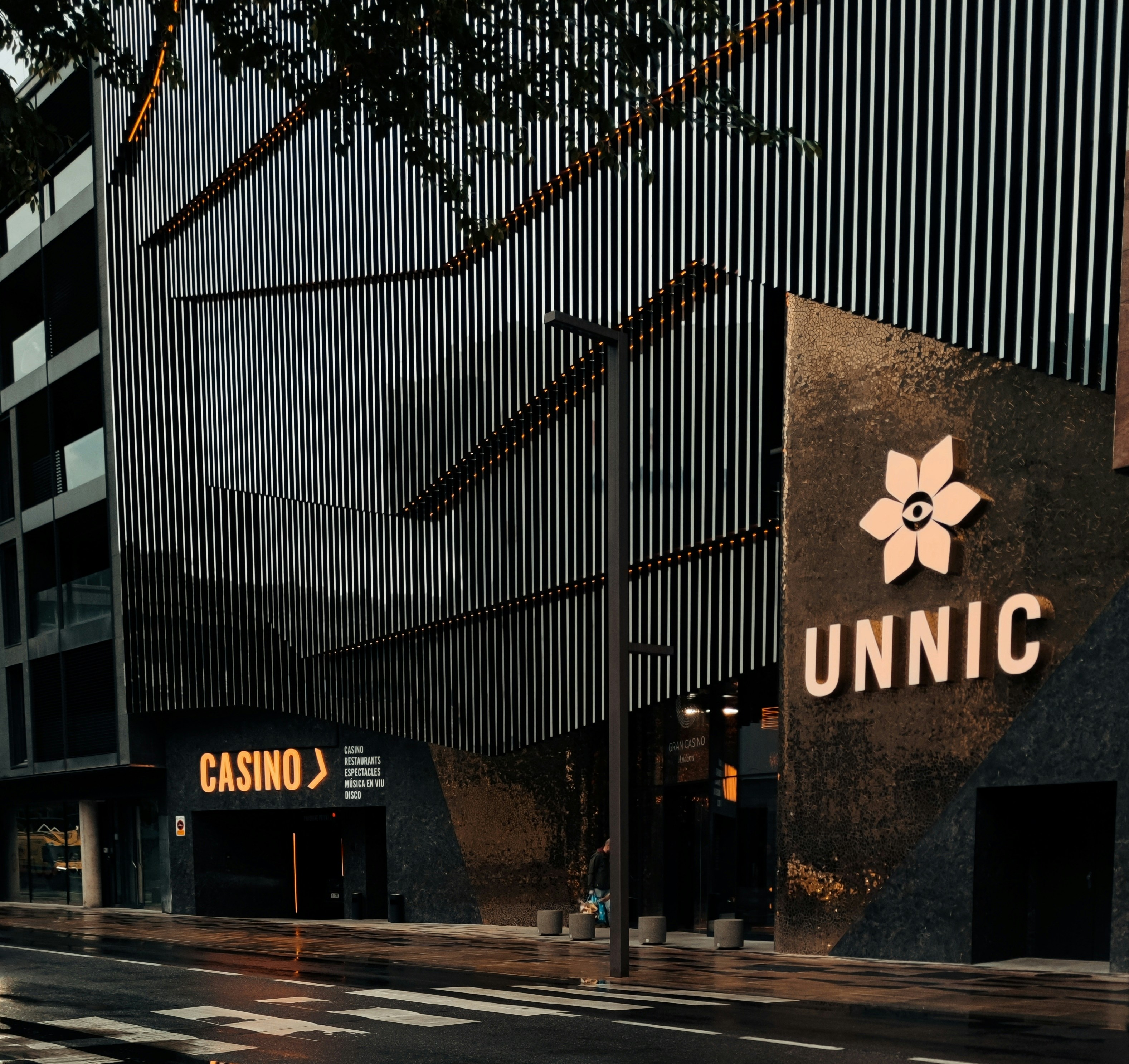 A building with a sign that says unic on it photo – Free Building Image ...