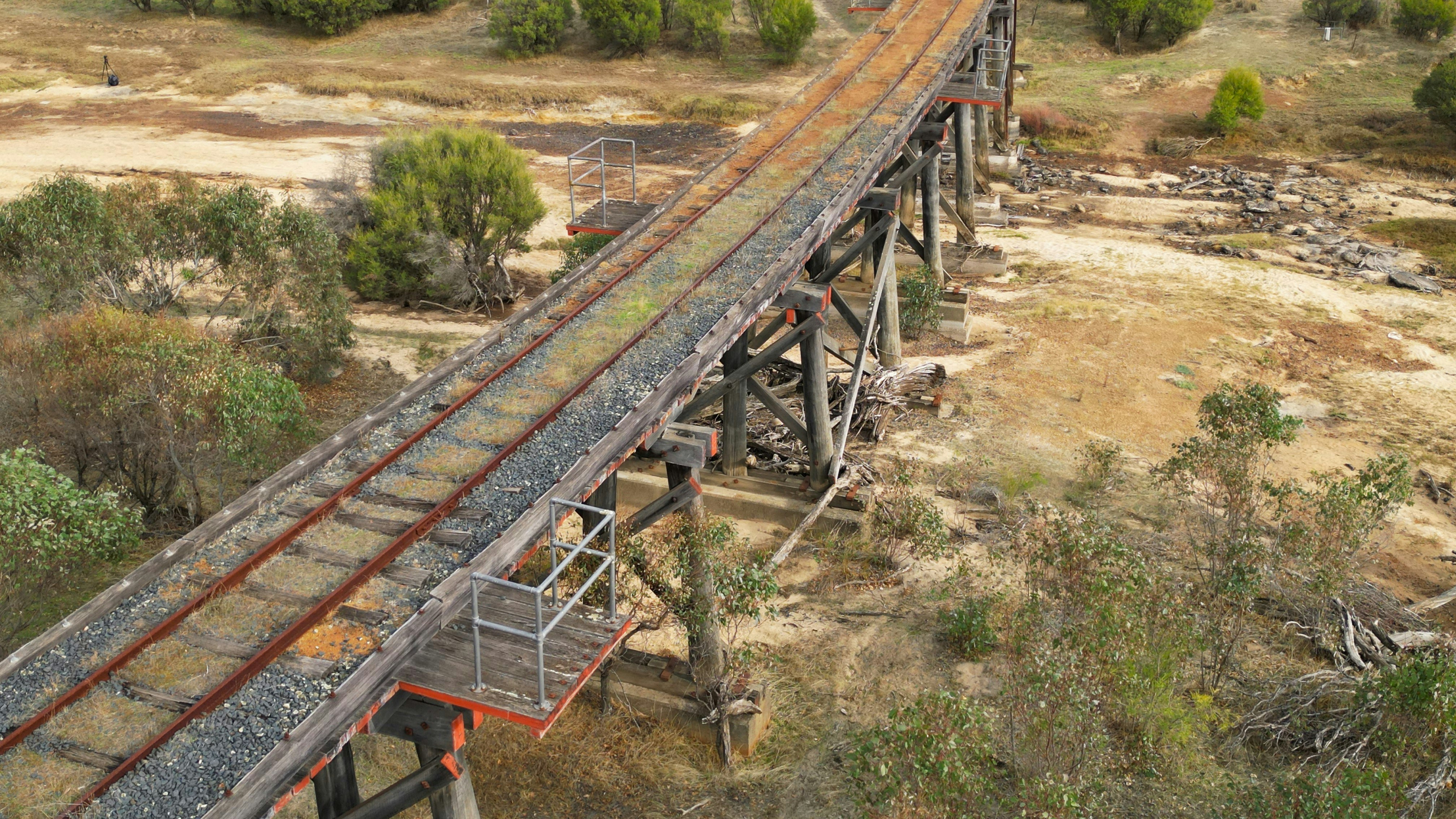 An overhead view of a train crossing a bridge photo – Free Railway ...