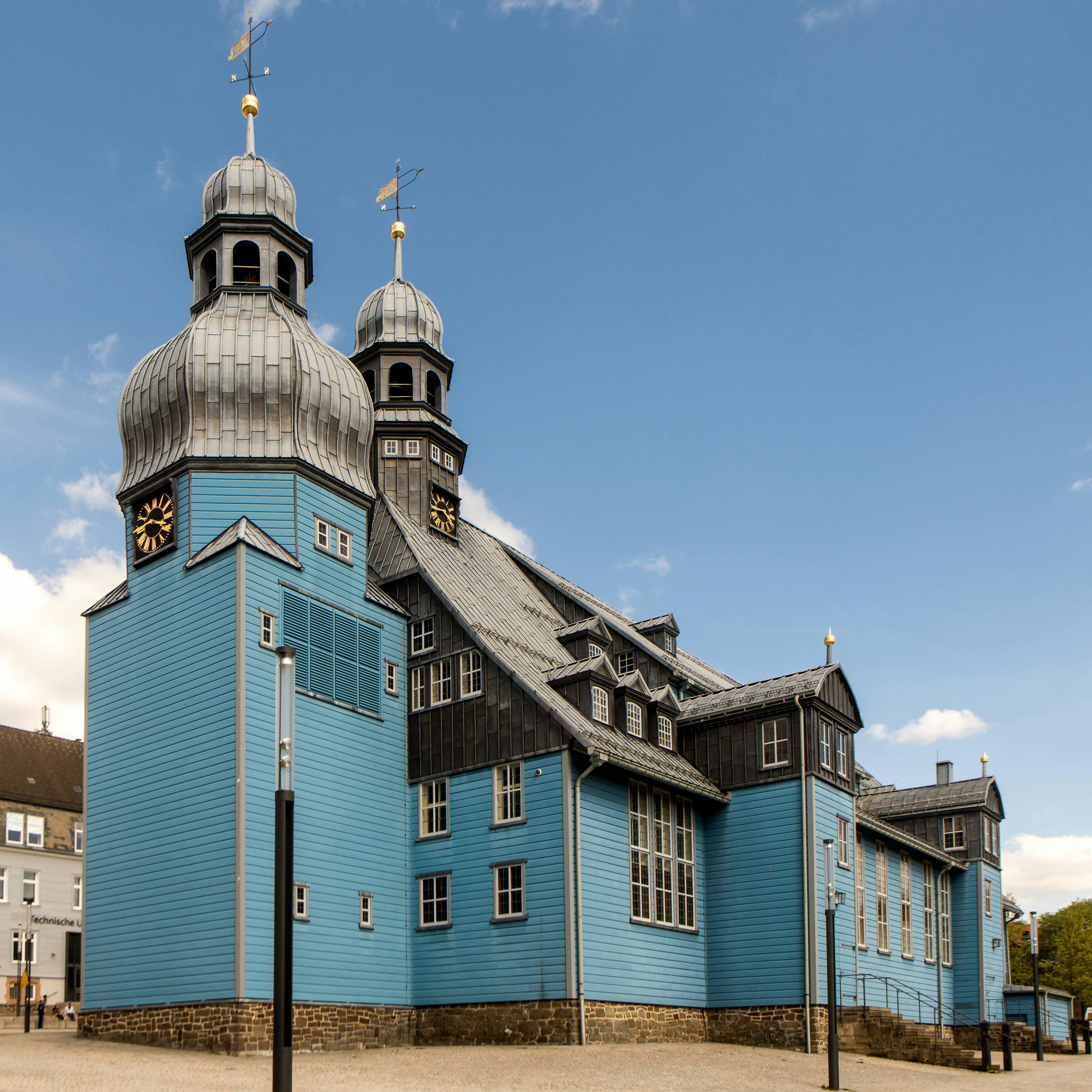 Blue Timbered Cathedral: A Nordic Clocktower Among the Rooftops