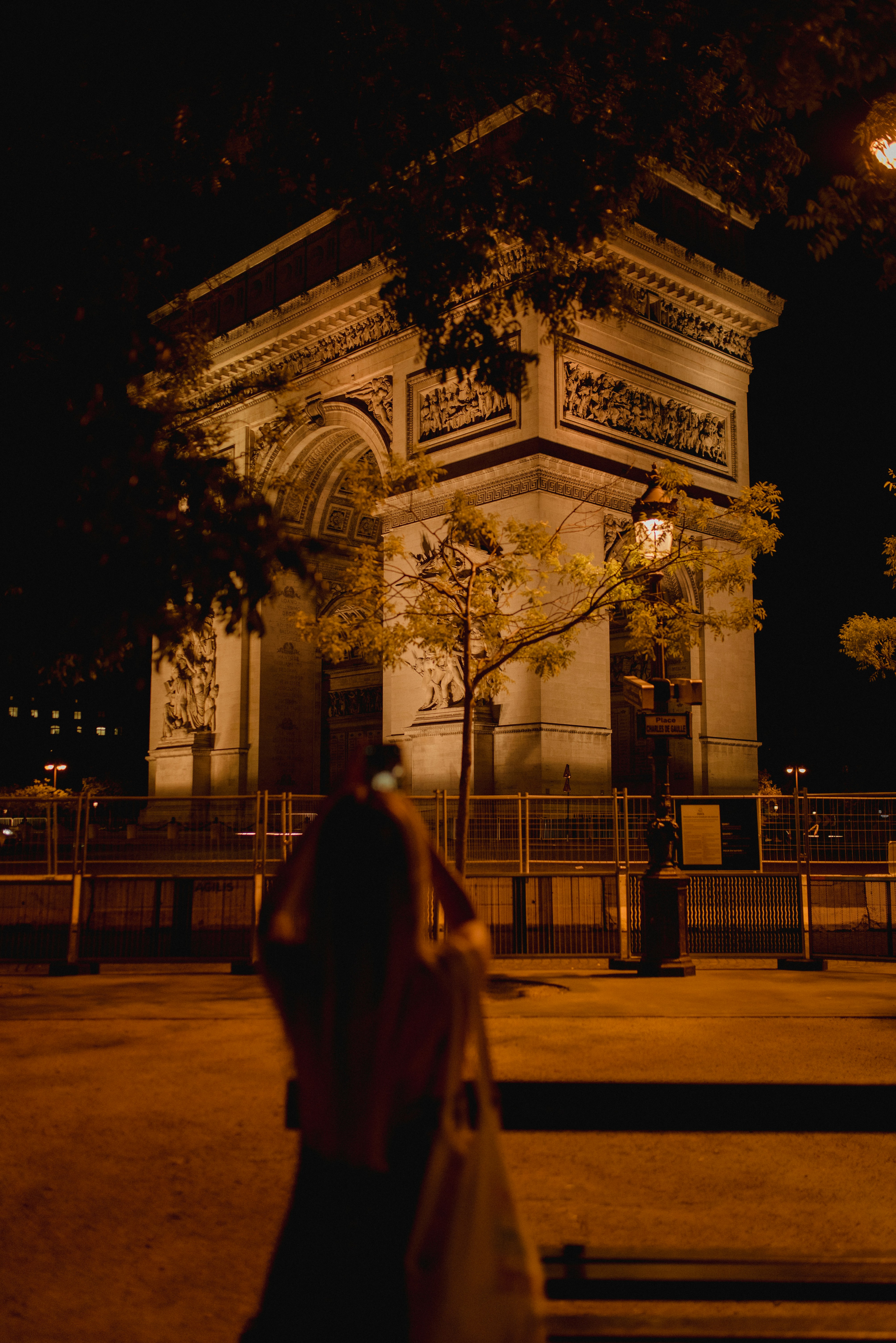 Arc of Night: Quiet Figures Before a Monument