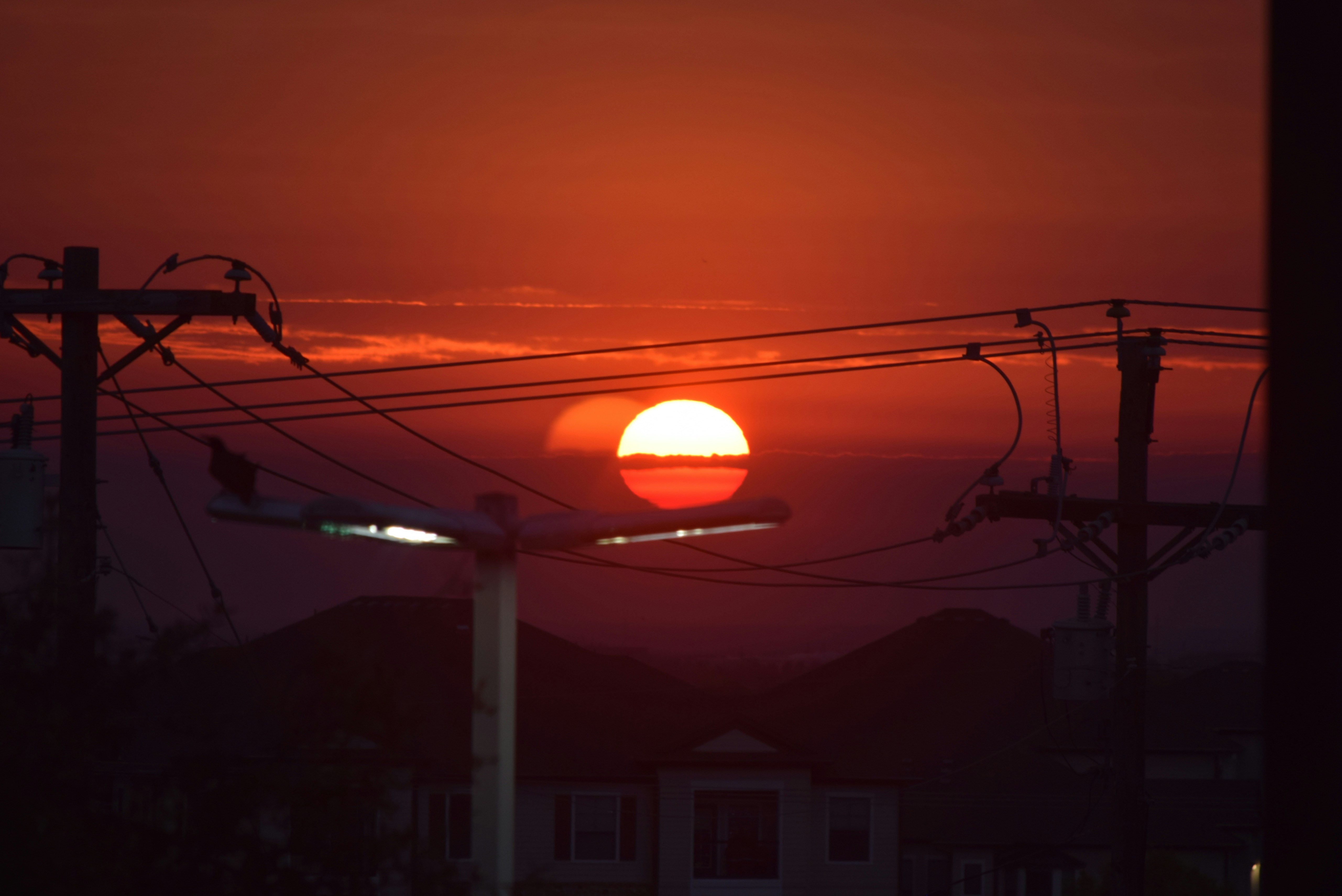 The sun is setting behind power lines and telephone poles photo – Free ...