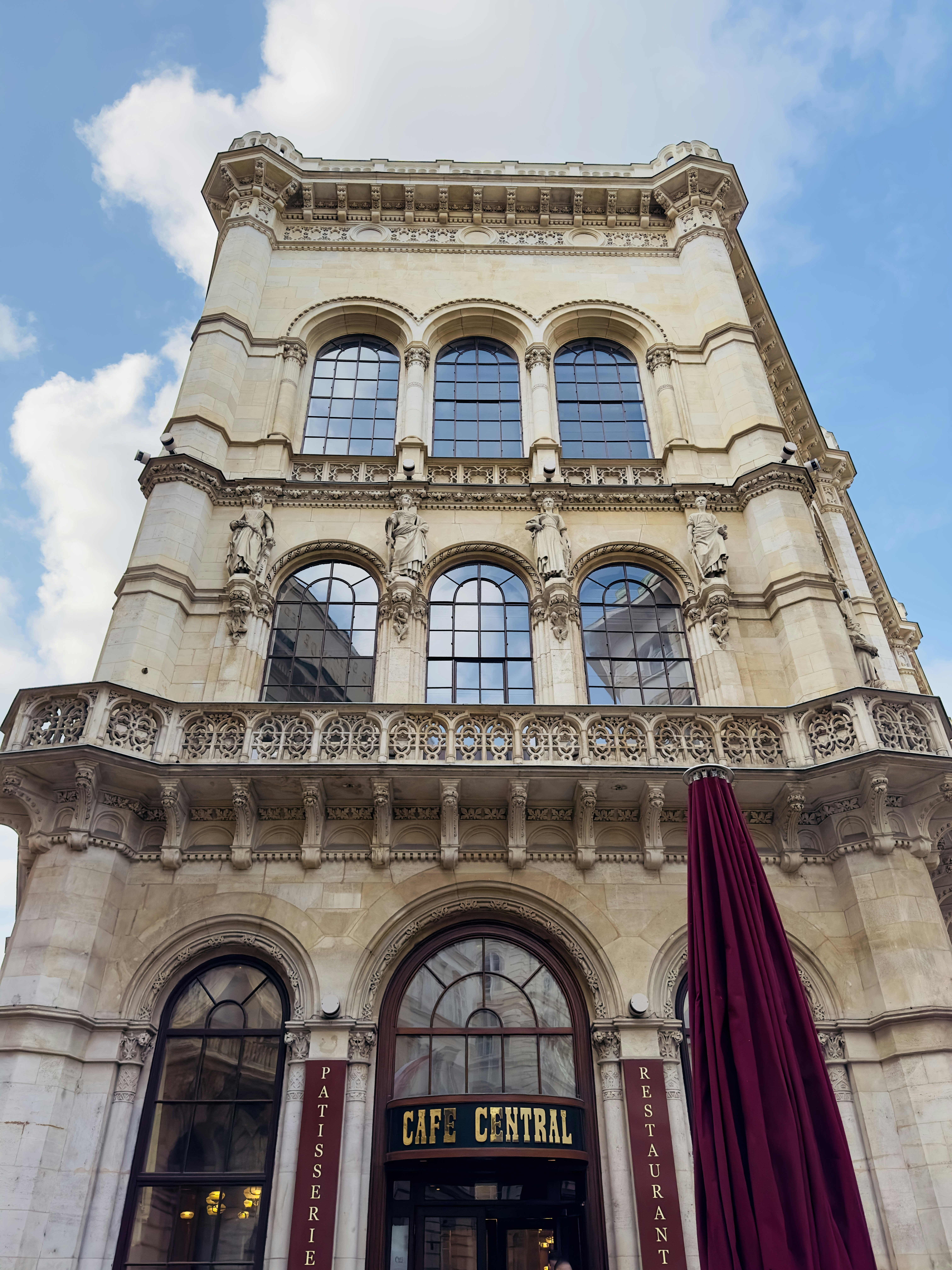 A tall building with a red umbrella in front of it photo – Free Vienna ...