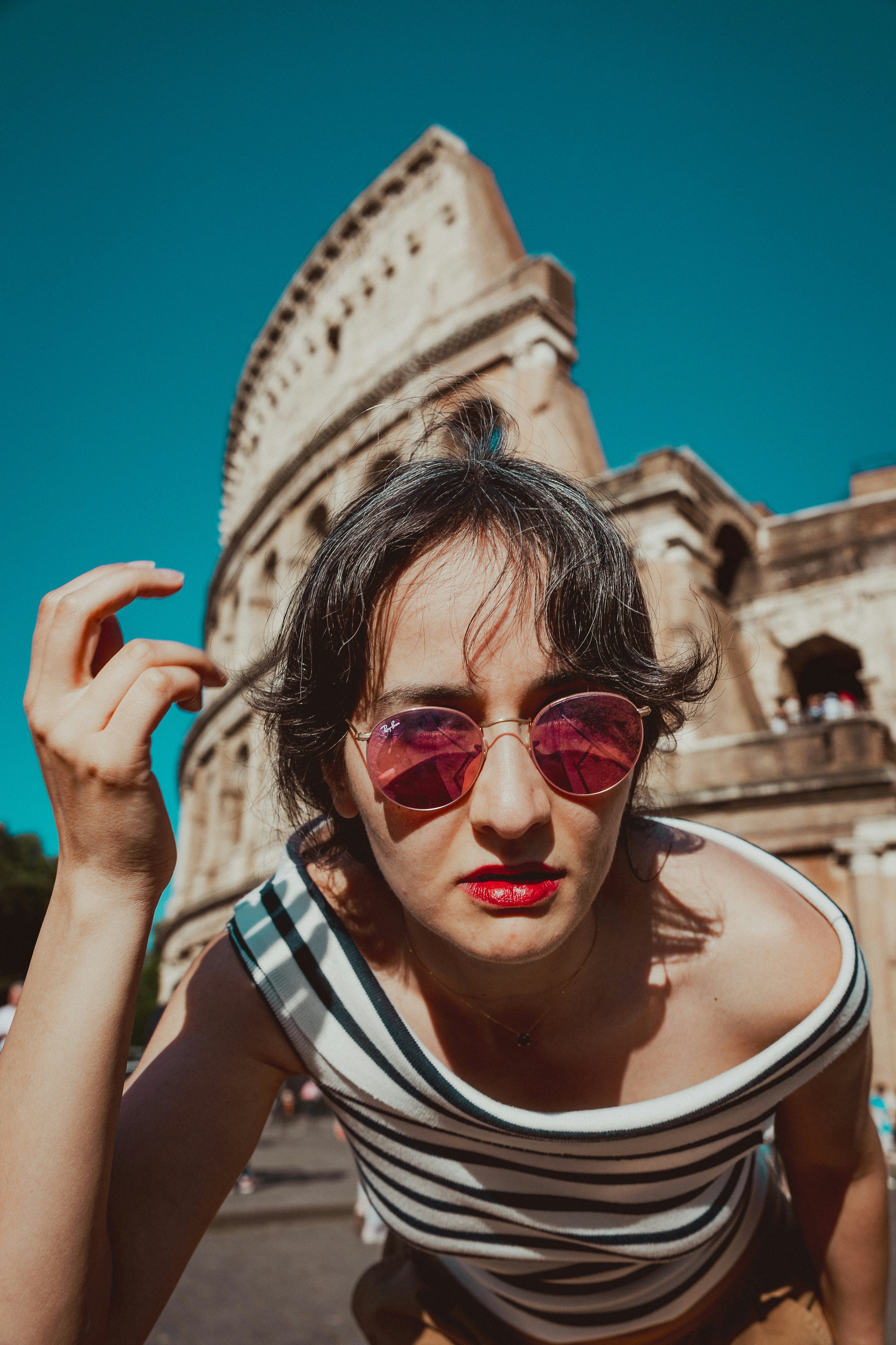 Crimson Lips and Pink Glasses Before the Colosseum