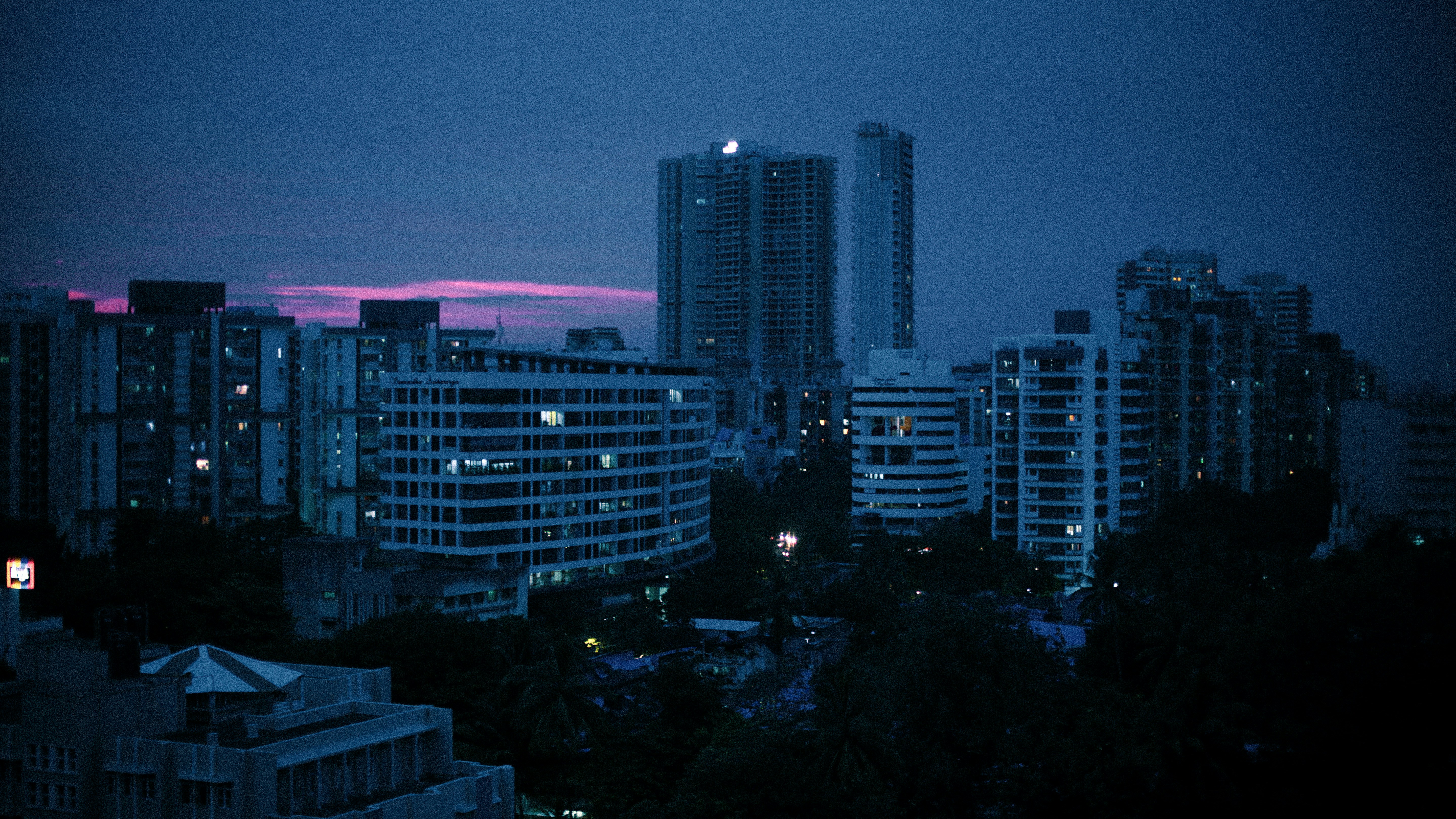 Blue Hour Sentinel: Twin Towers Over a Quiet Neon City