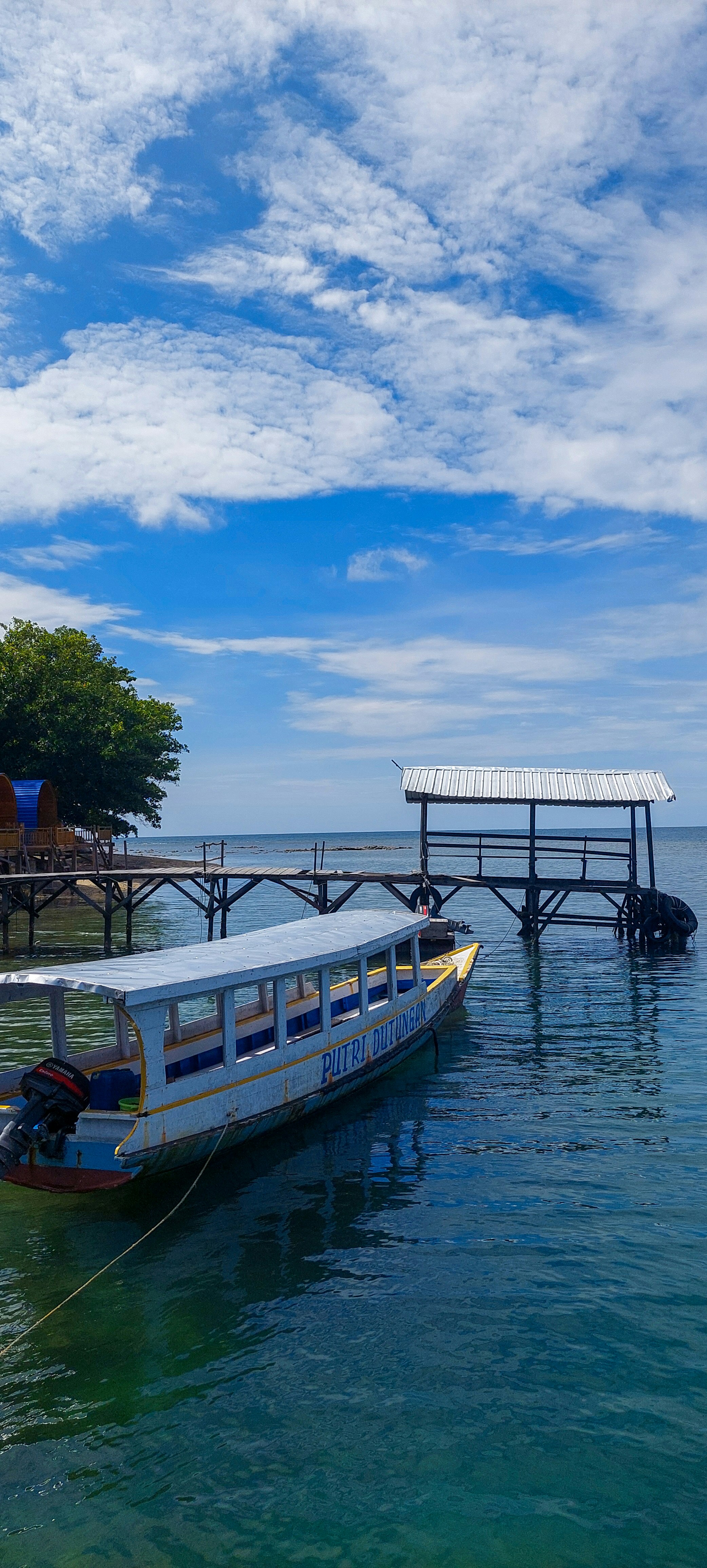 A boat docking at the pier. Dutungan Island, South Sulawesi, Indonesia.