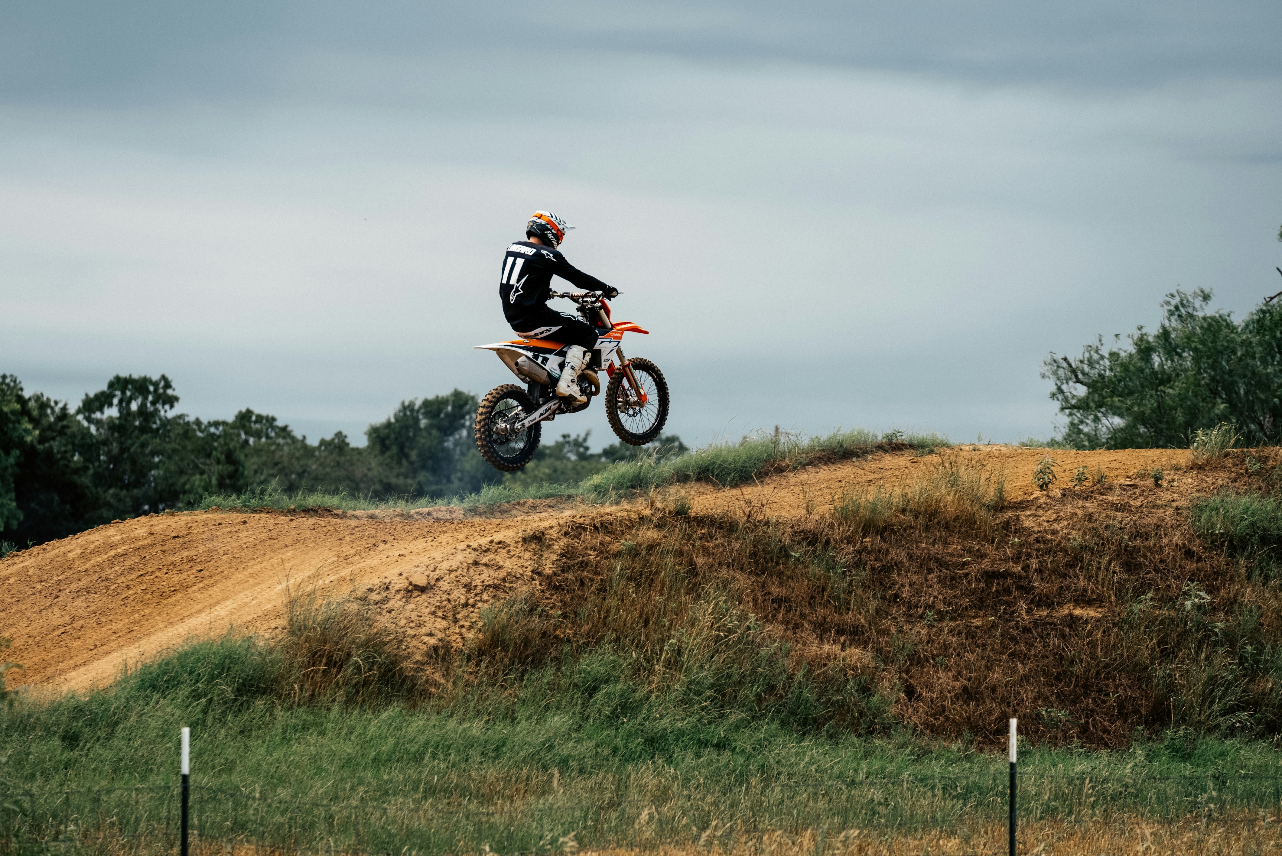 A person on a dirt bike jumping over a hill photo – Free Jump Image on ...