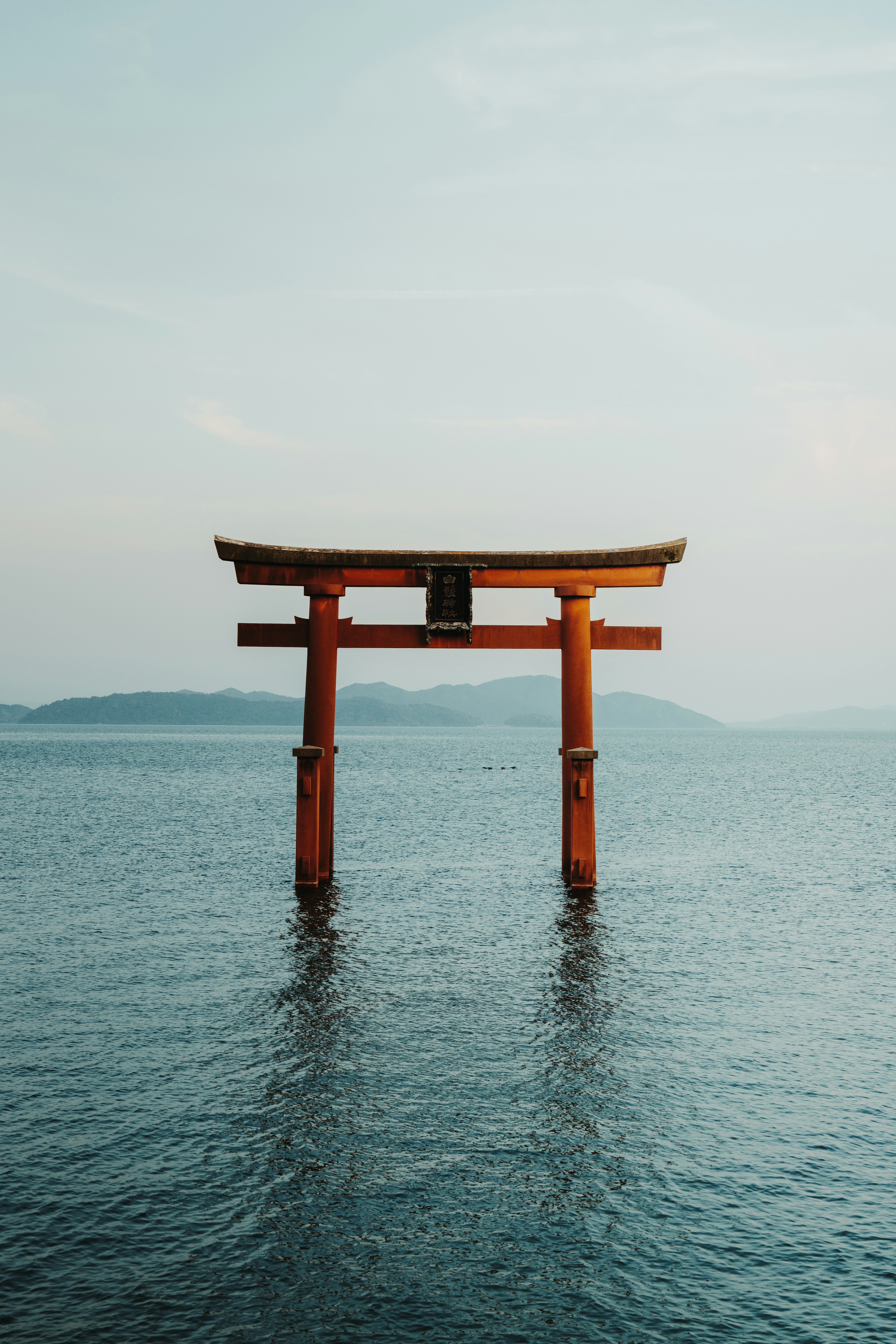 A large body of water with a wooden structure in the middle of it photo ...