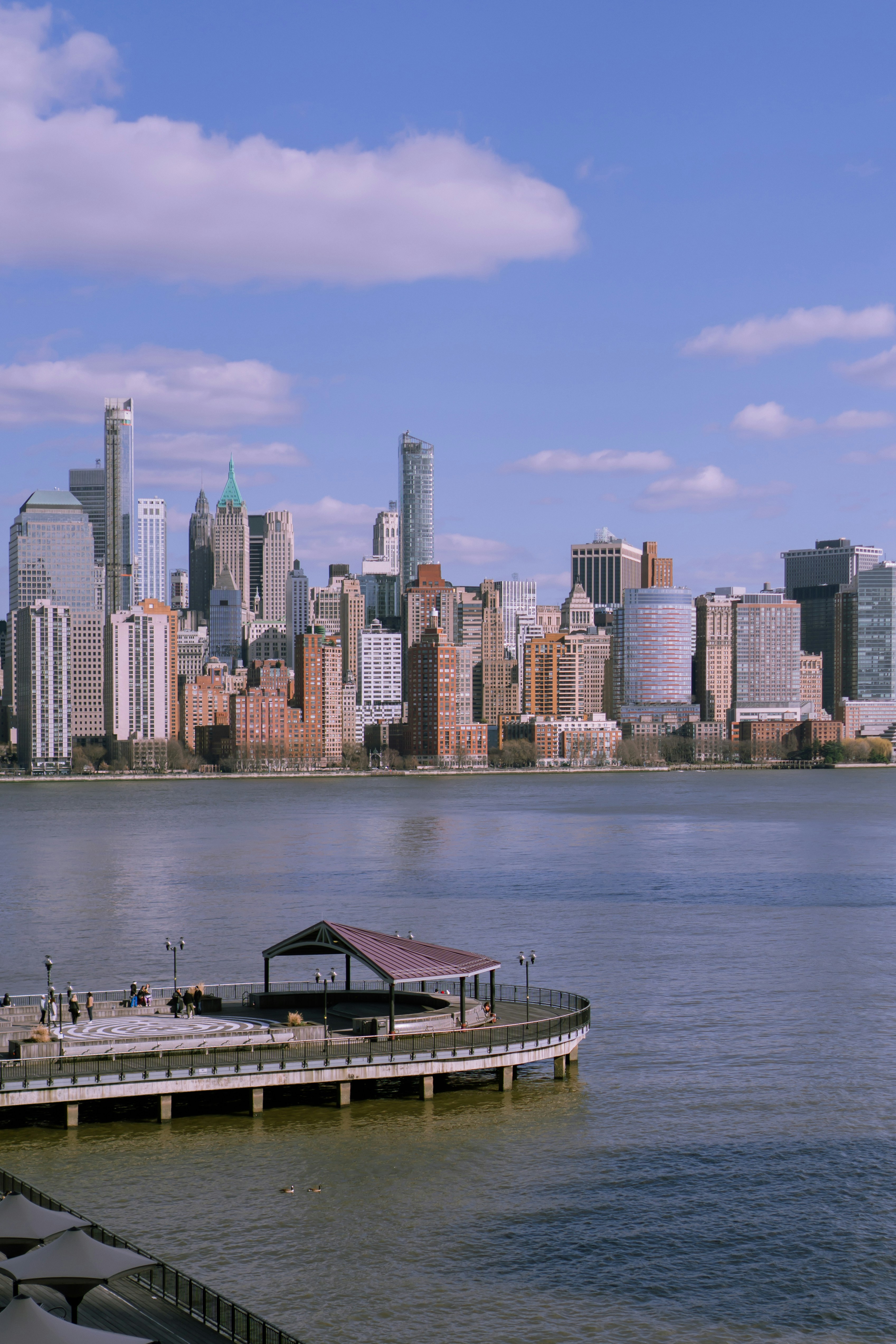 A boat dock in front of a large city photo – Free Colgate center Image ...
