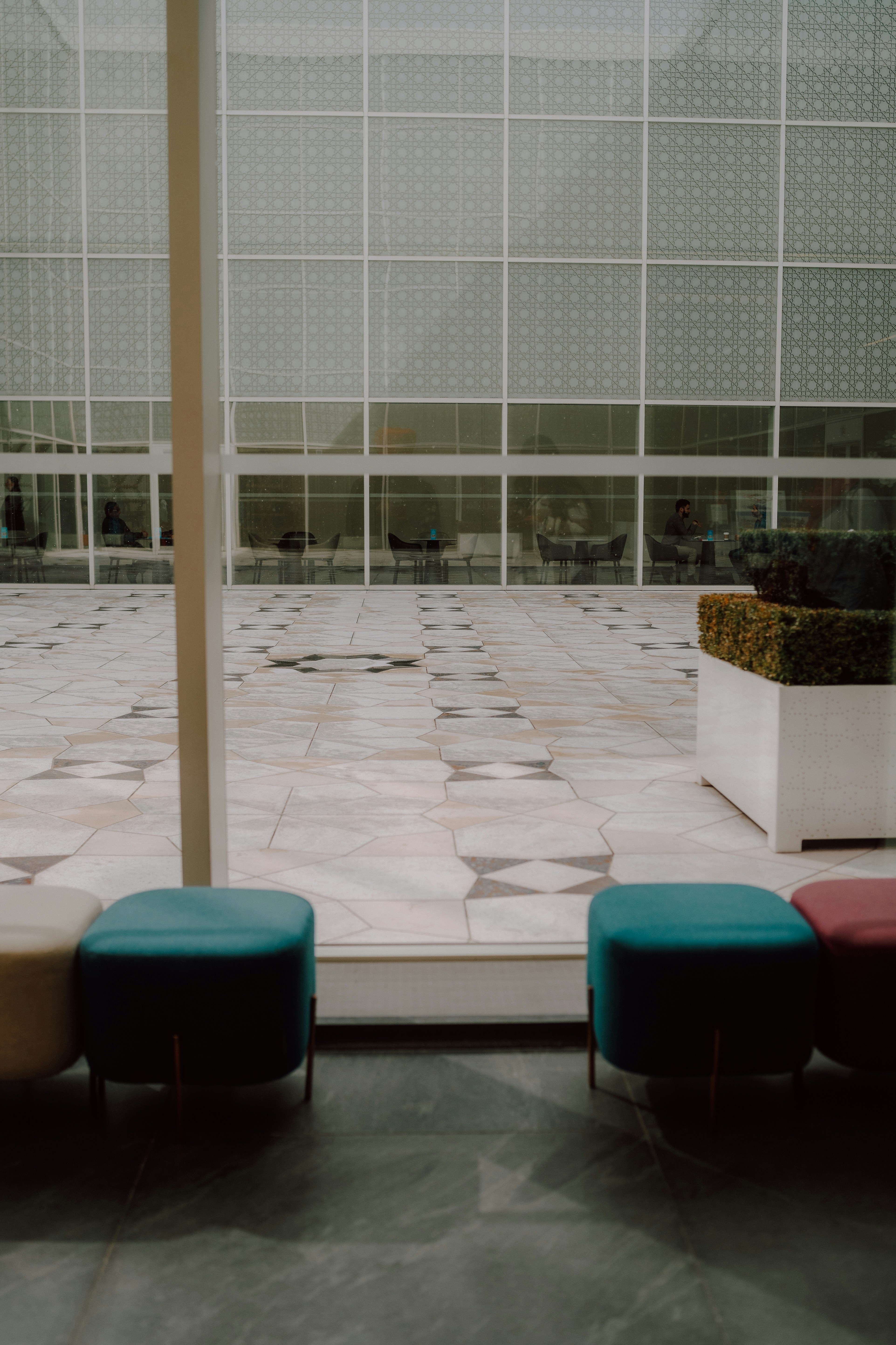 A room with a tiled floor and four stools photo – Free Image on Unsplash