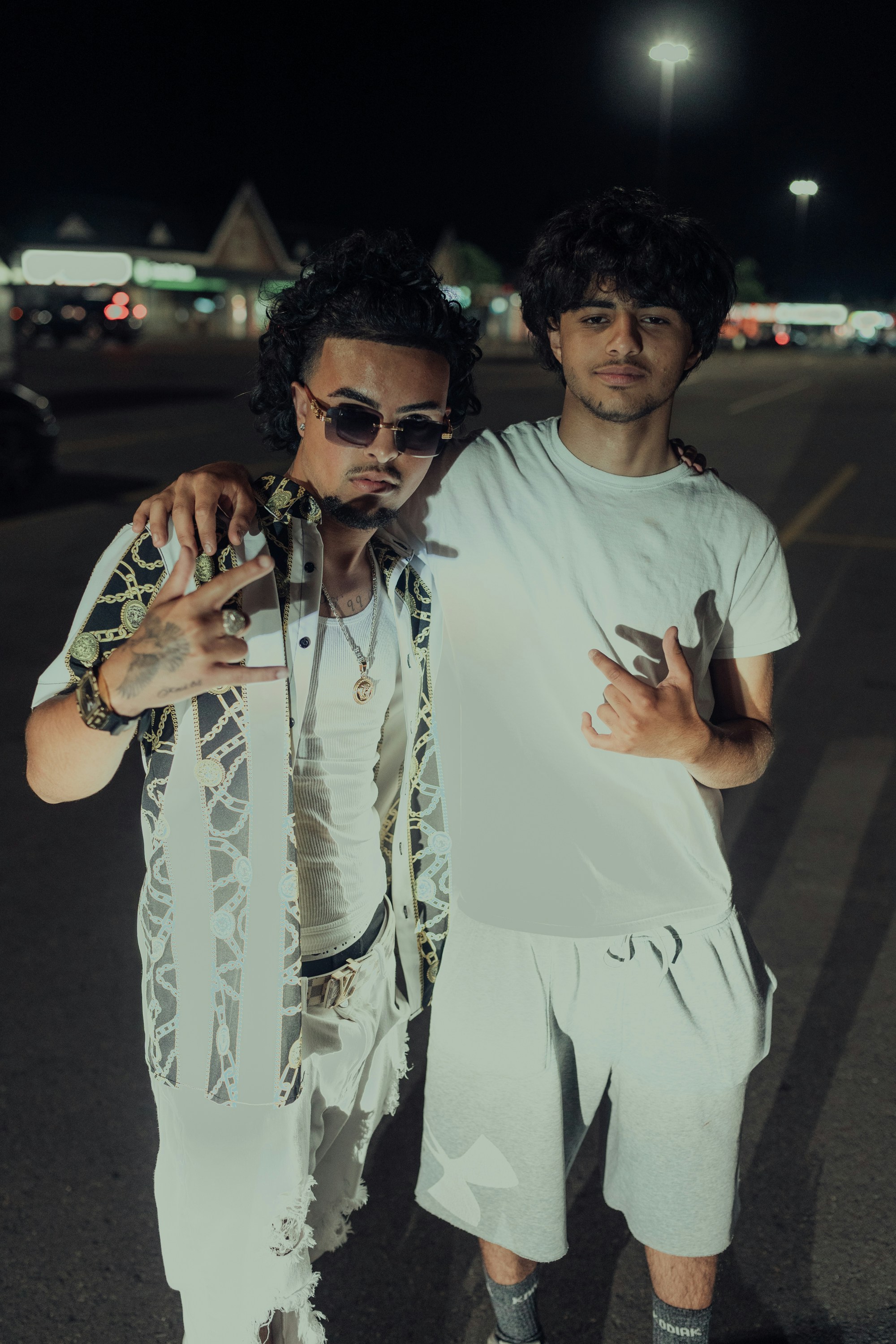 Two men standing next to each other in a parking lot photo – Free Image ...