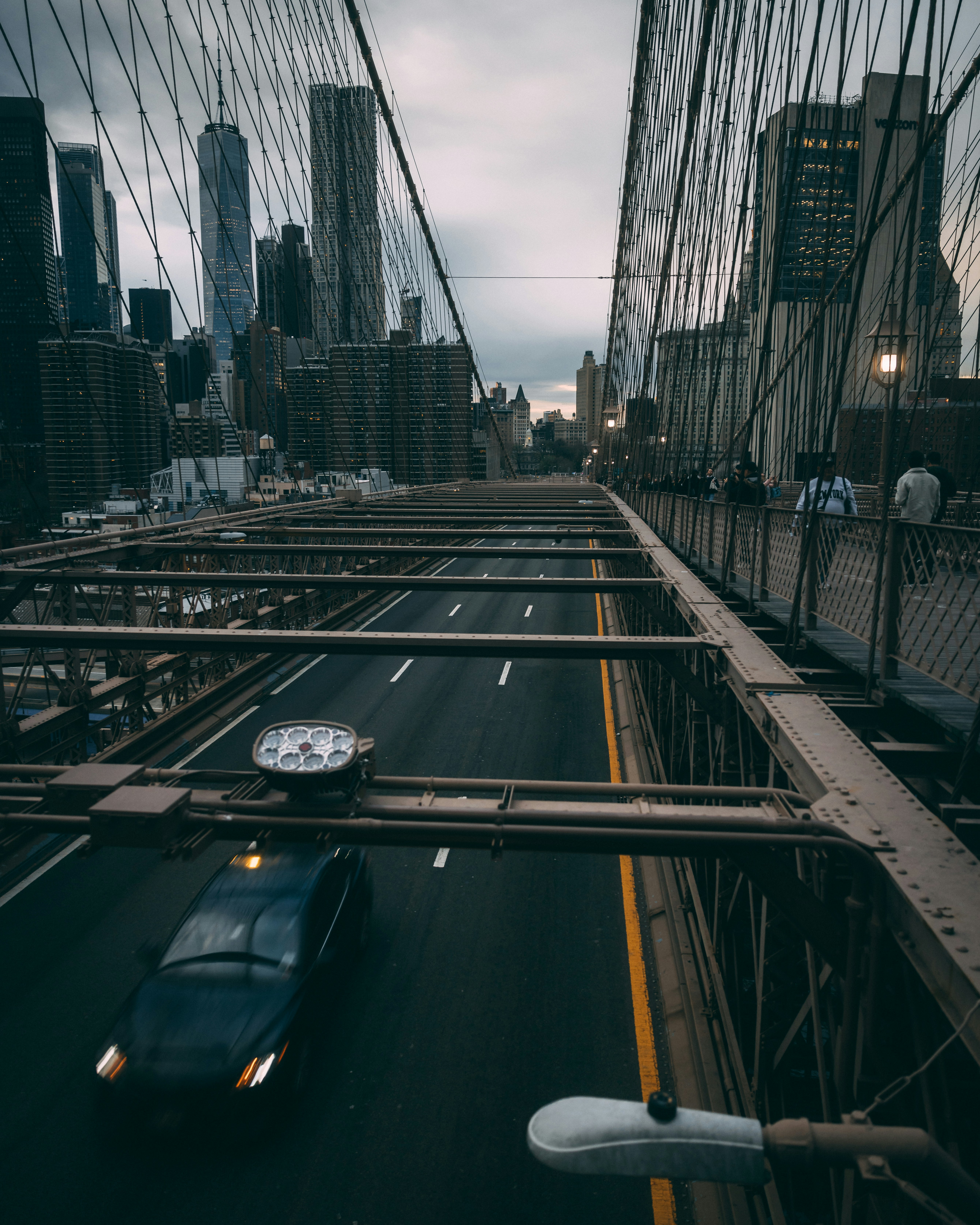 A car driving across a bridge in a city photo – Free Brooklyn bridge ...