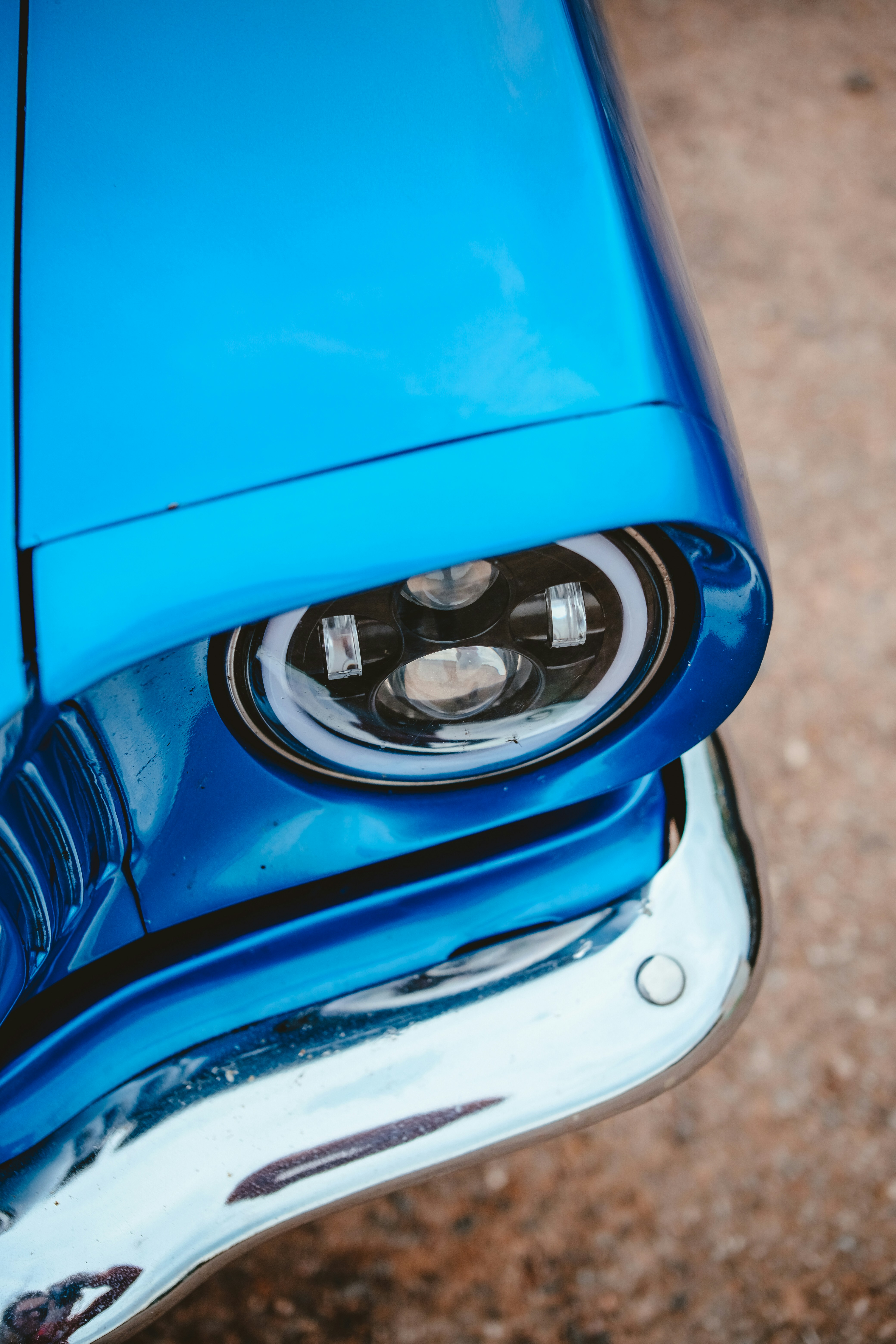 Cerulean Gaze: Close-Up of a Vintage Car Headlight in Chrome