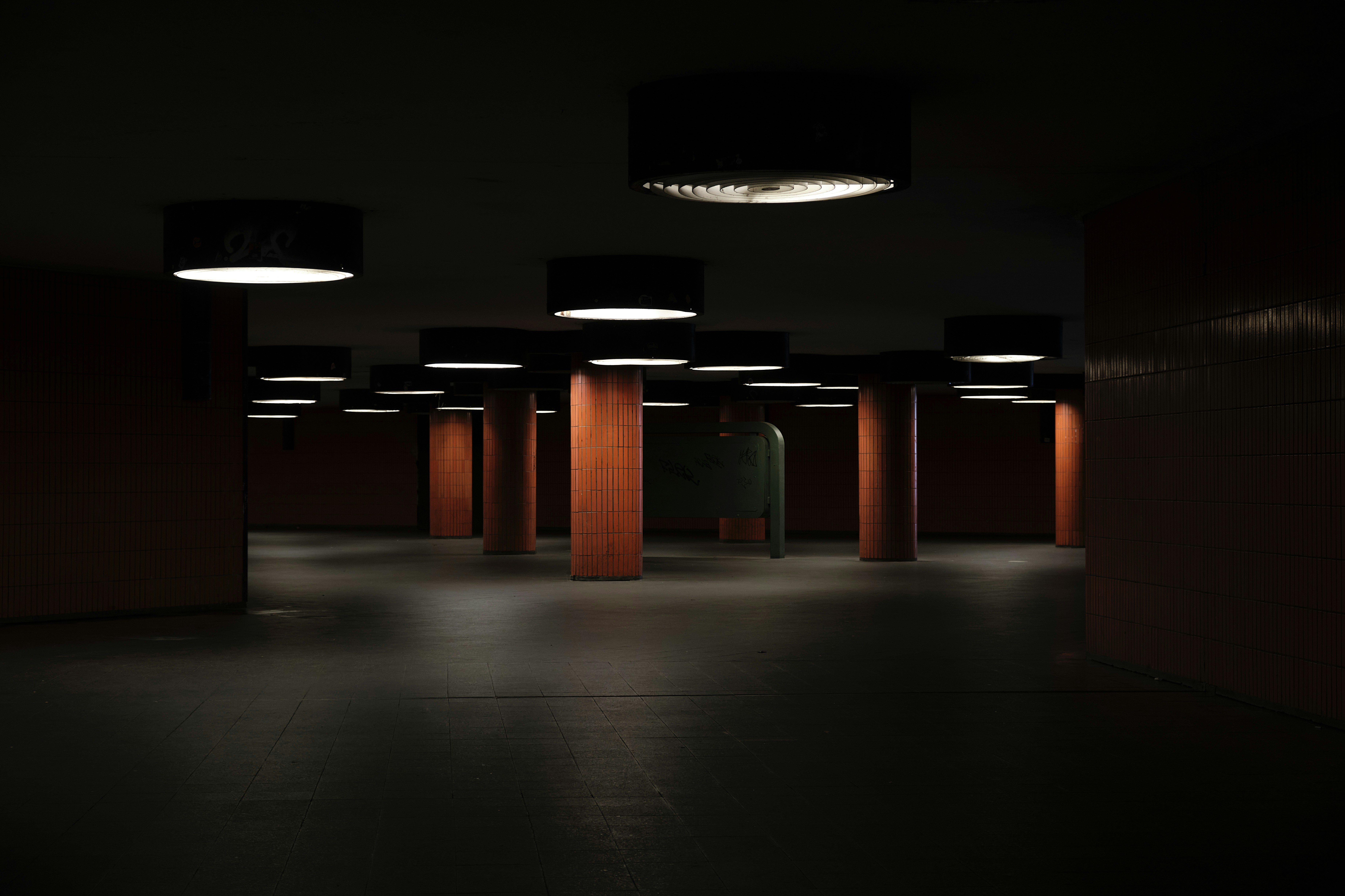 A dimly lit room with several lights on the ceiling photo – Free Berlin ...