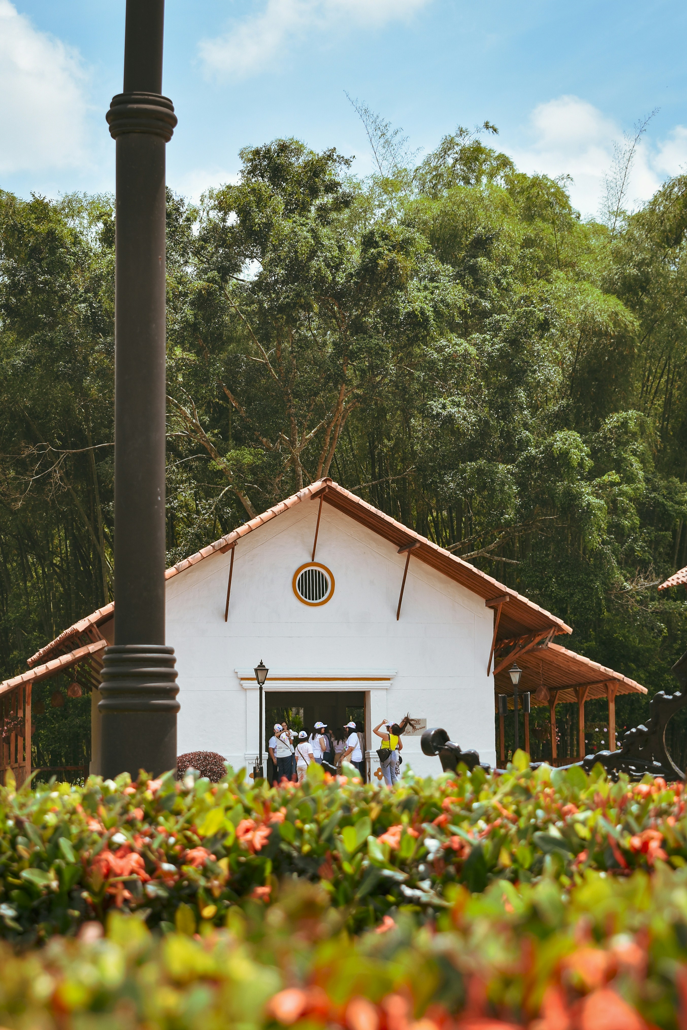 Gathering at a White Cottage Entrance Amid Jungle Foliage
