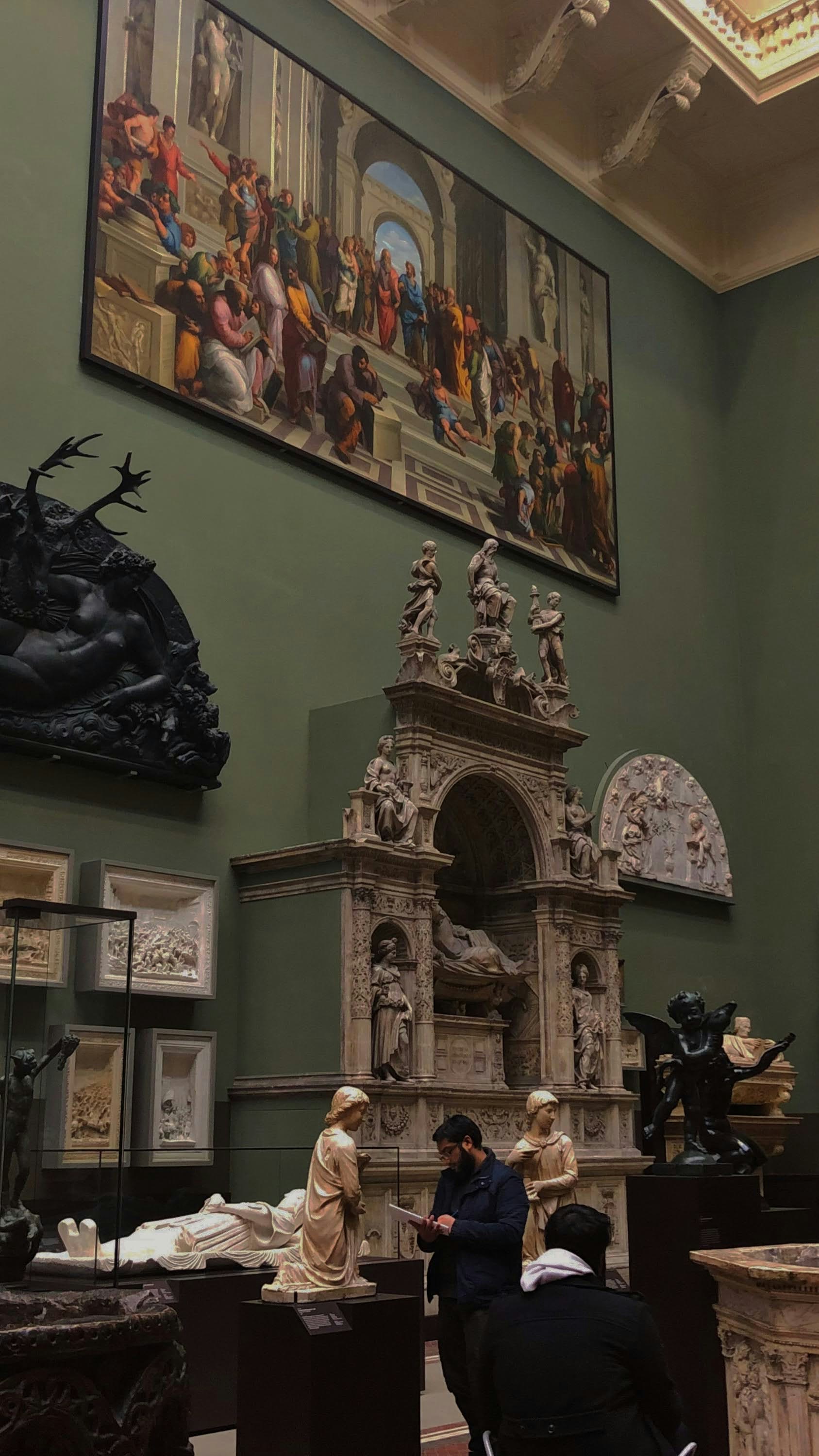 A group of people looking at statues in a museum photo – Free Woman ...