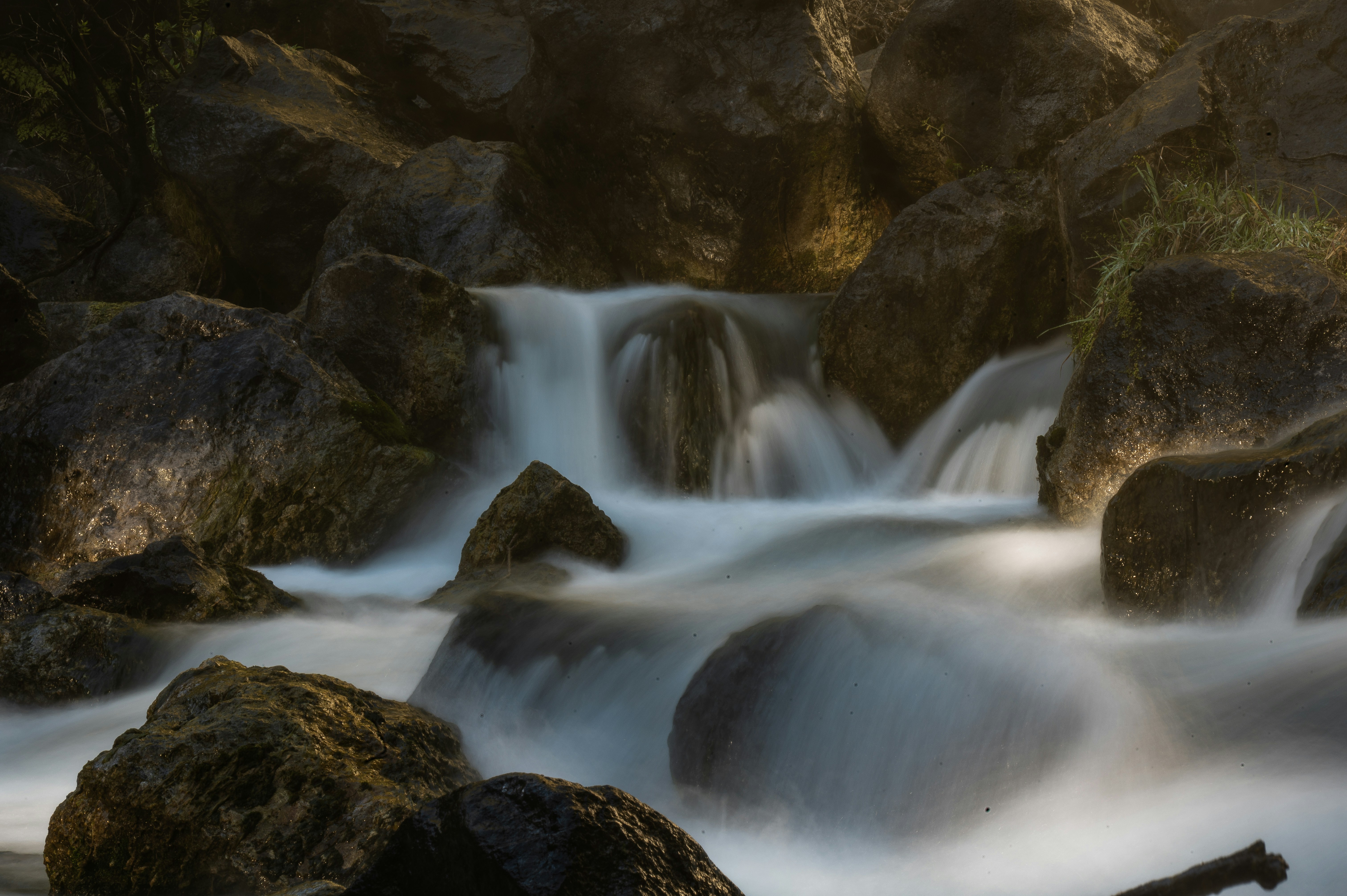 A stream of water running over rocks in a forest photo – Free Grey ...