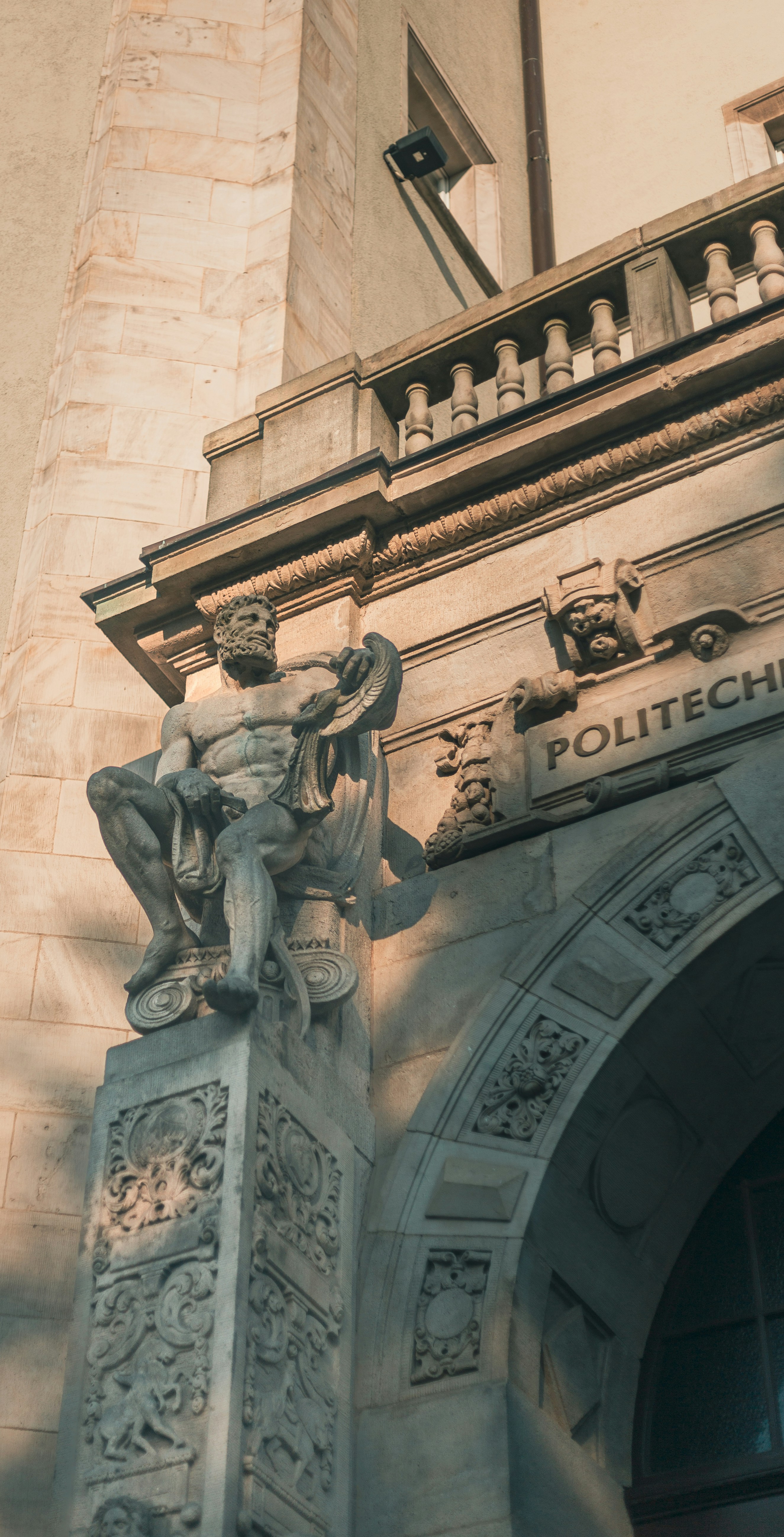 Atlas on the Polytechnic Arch: Weathered Stone and Carved Majesty