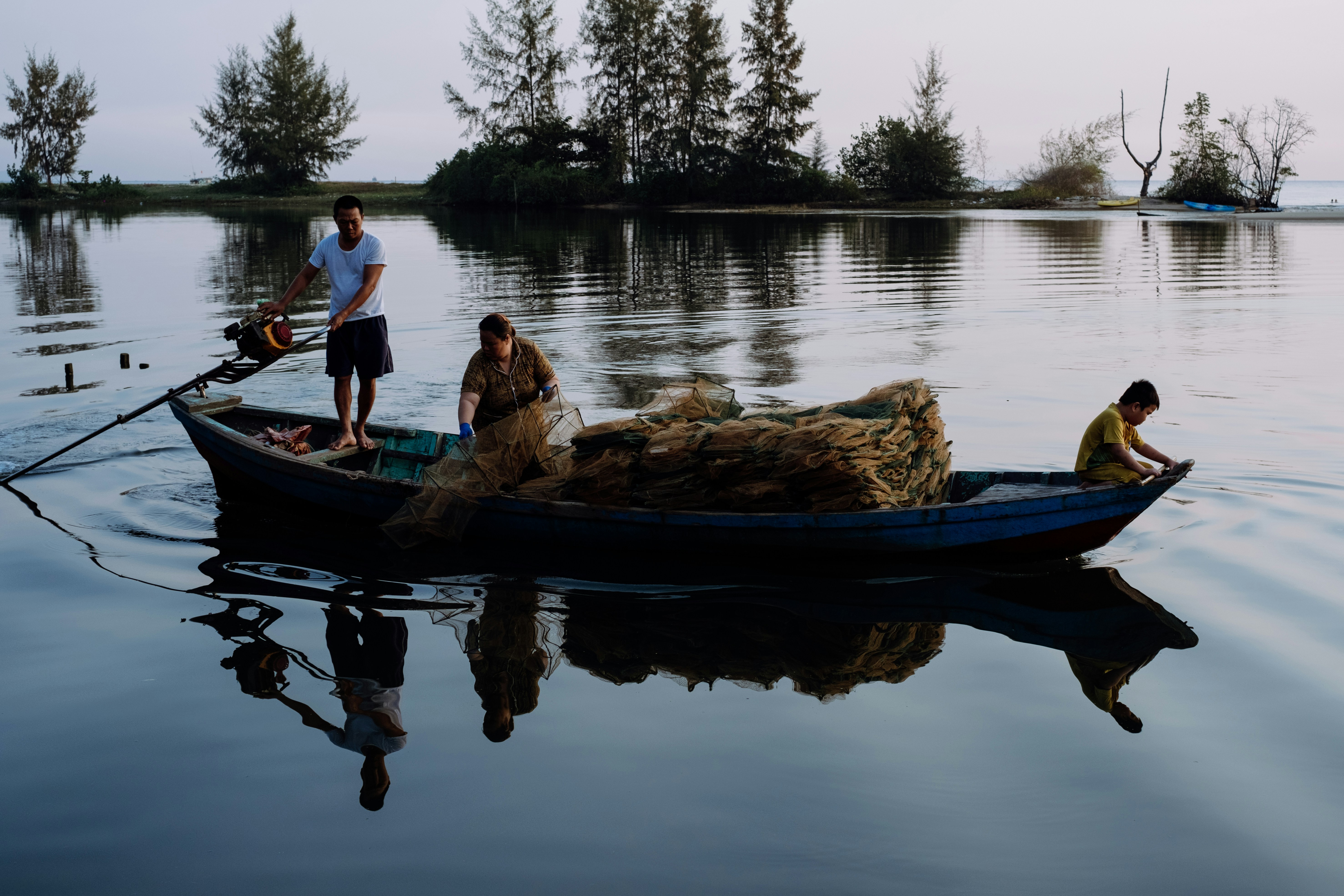 Boatmen at Dusk: A Small Vessel Poised on Serene Water