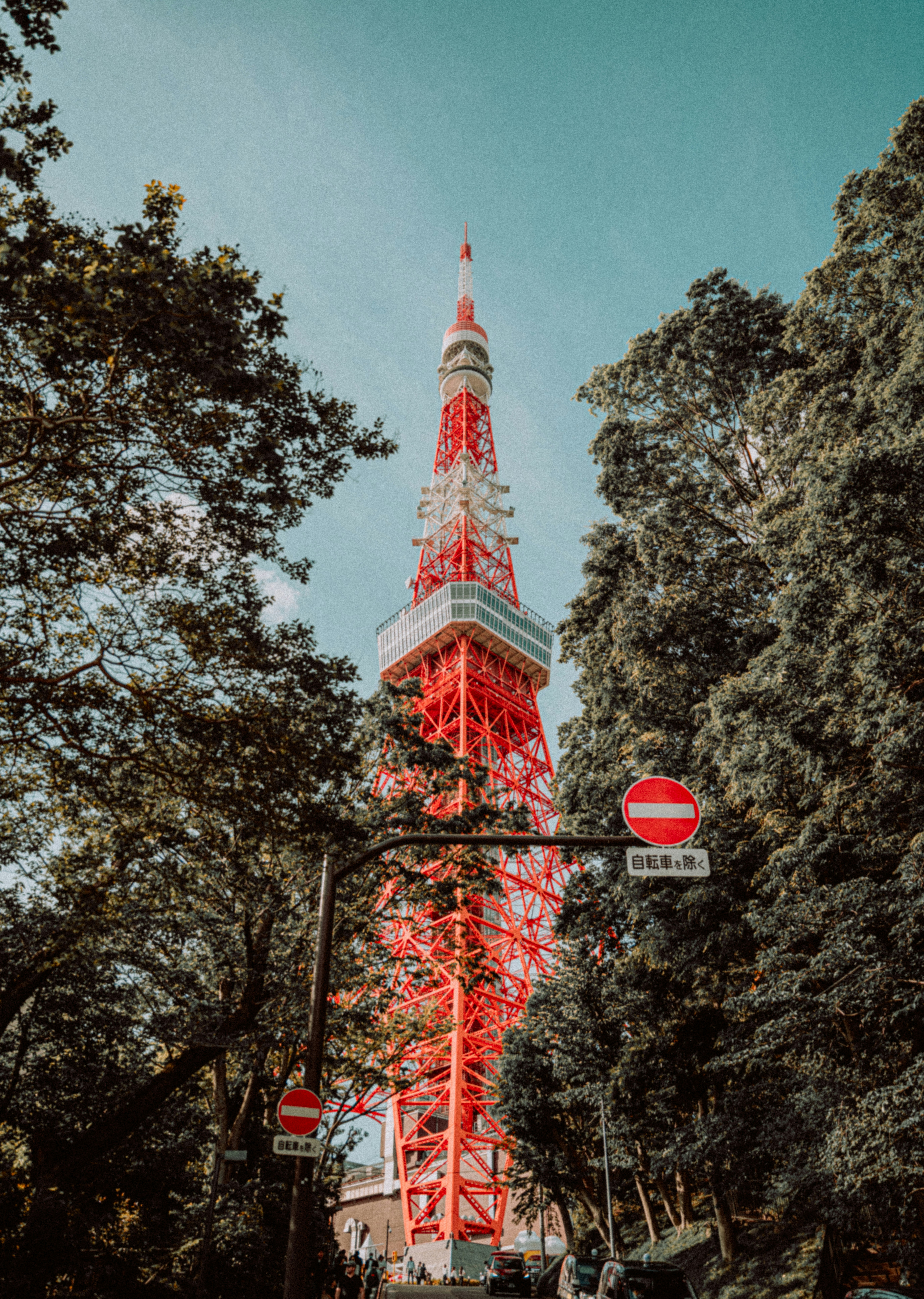 A very tall red tower towering over a city photo – Free Tower Image on ...