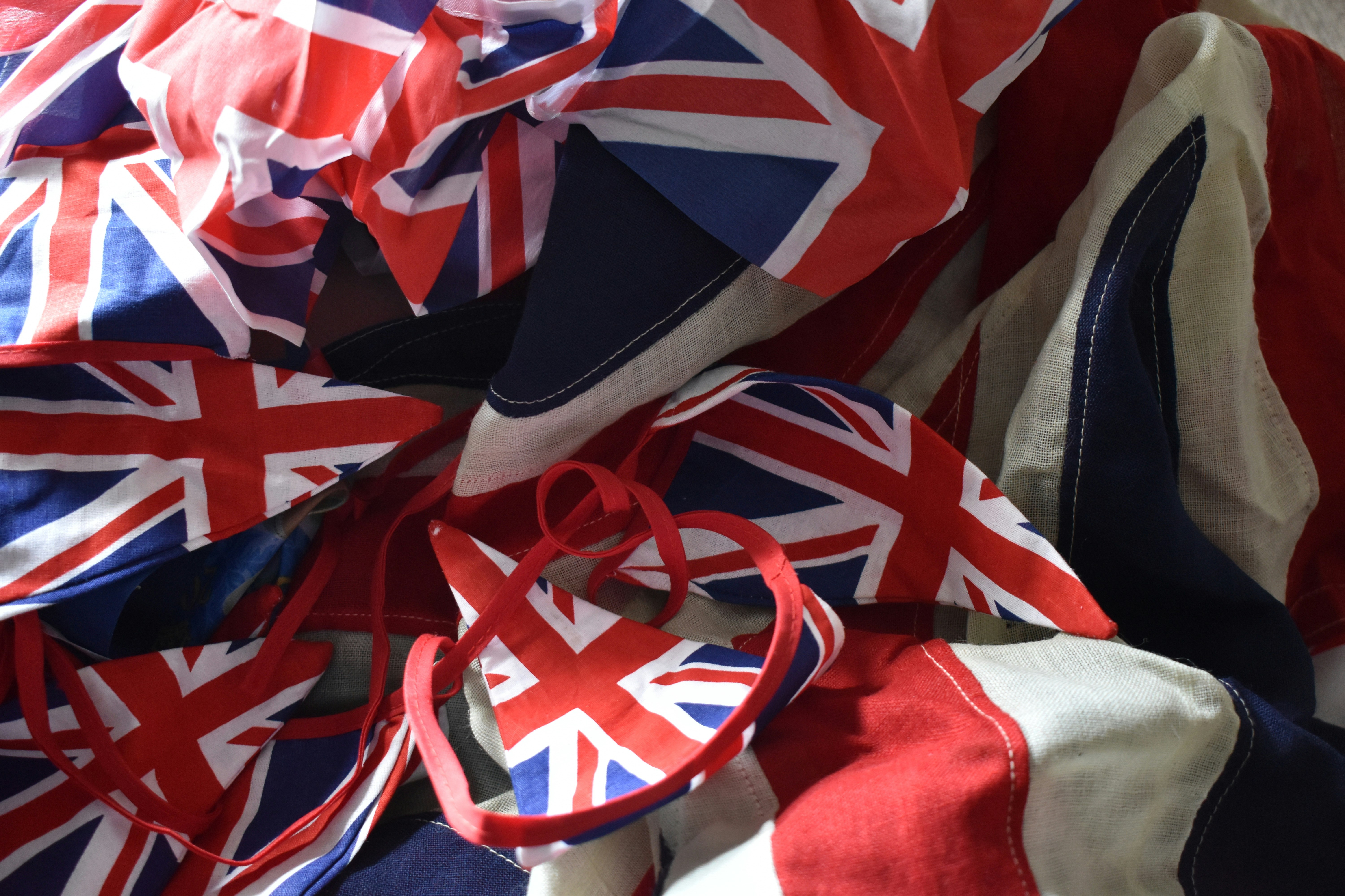 A pile of british and british flags laying on top of each other photo ...