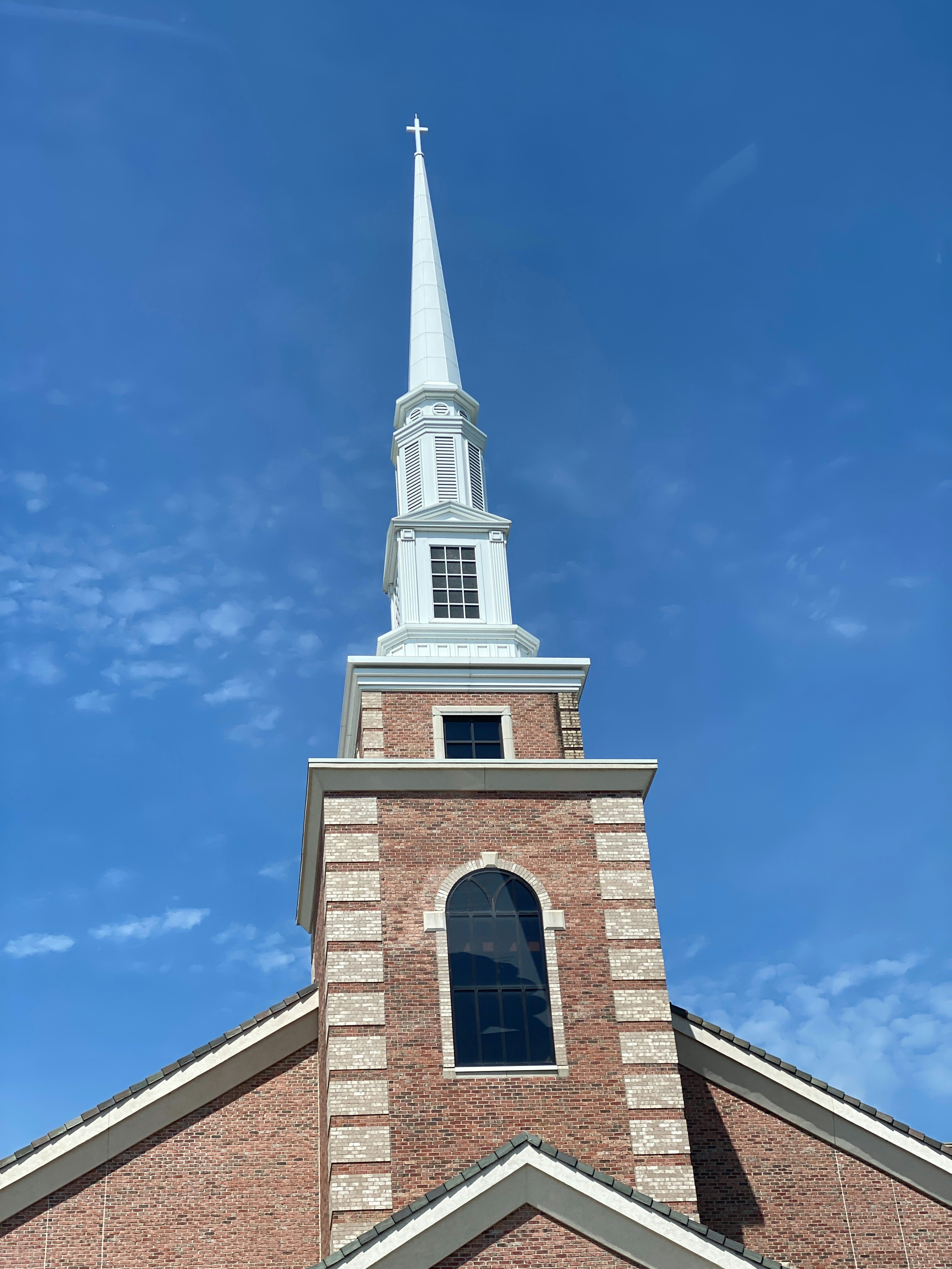 A church steeple against a blue sky with clouds photo – Free Redeemer ...