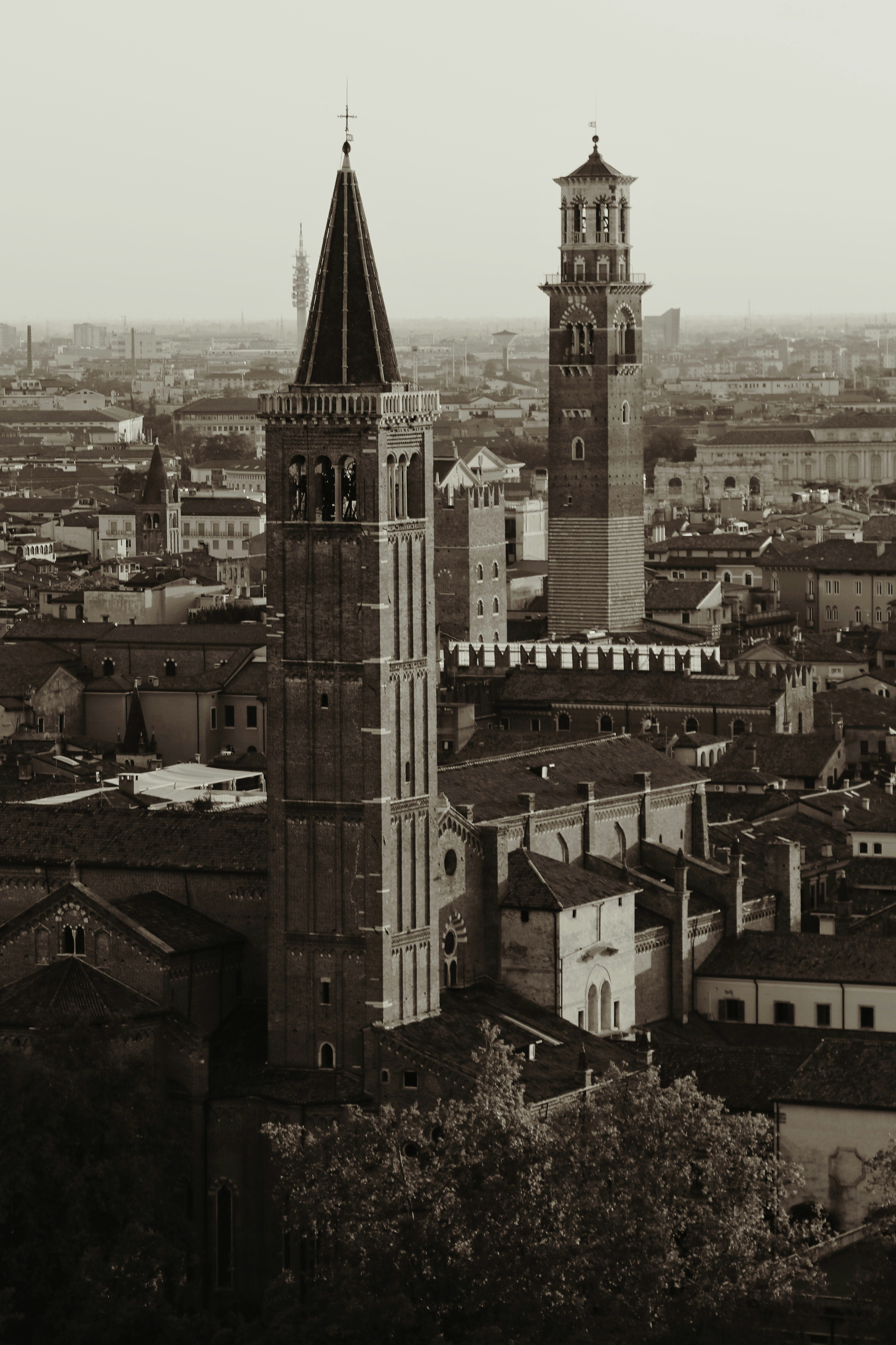Sepia Spires: Twin Bell Towers Rising Over an Ancient Cityscape